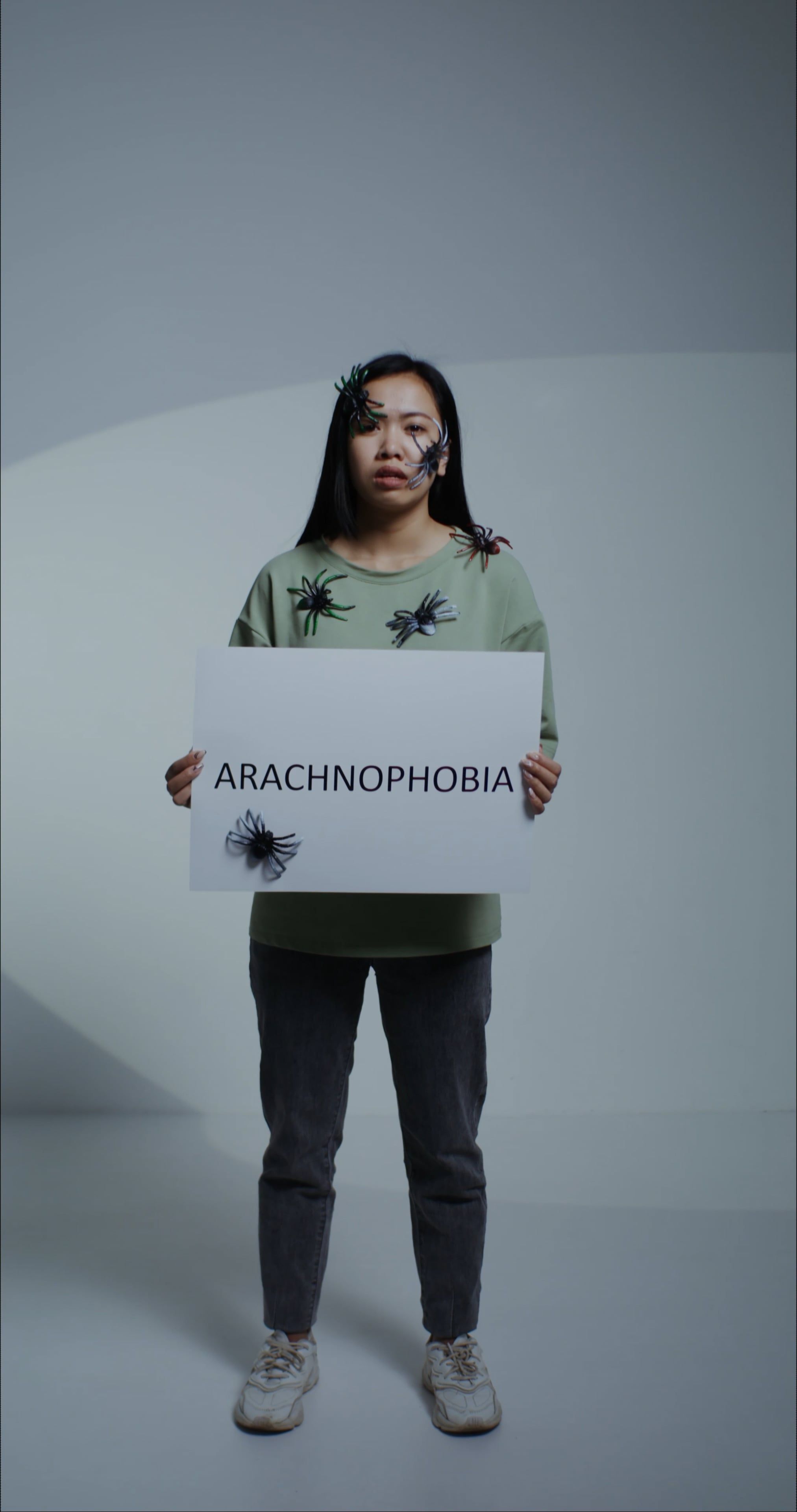 Scared Woman Holding A Sign Of Arachnophobia · Free Stock Video