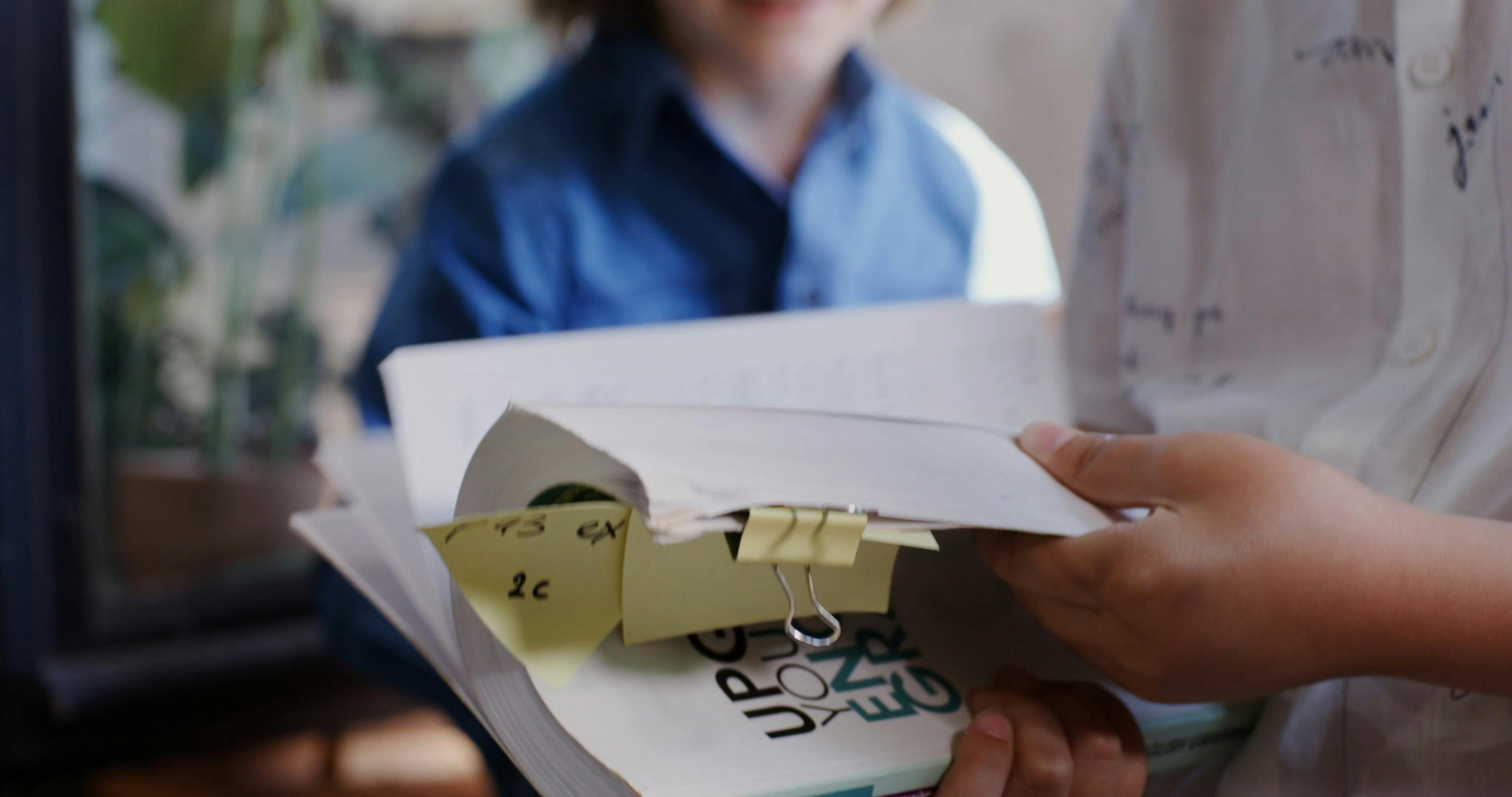 A Person Flipping Pages of a Textbook Free Stock Video Footage, Royalty ...