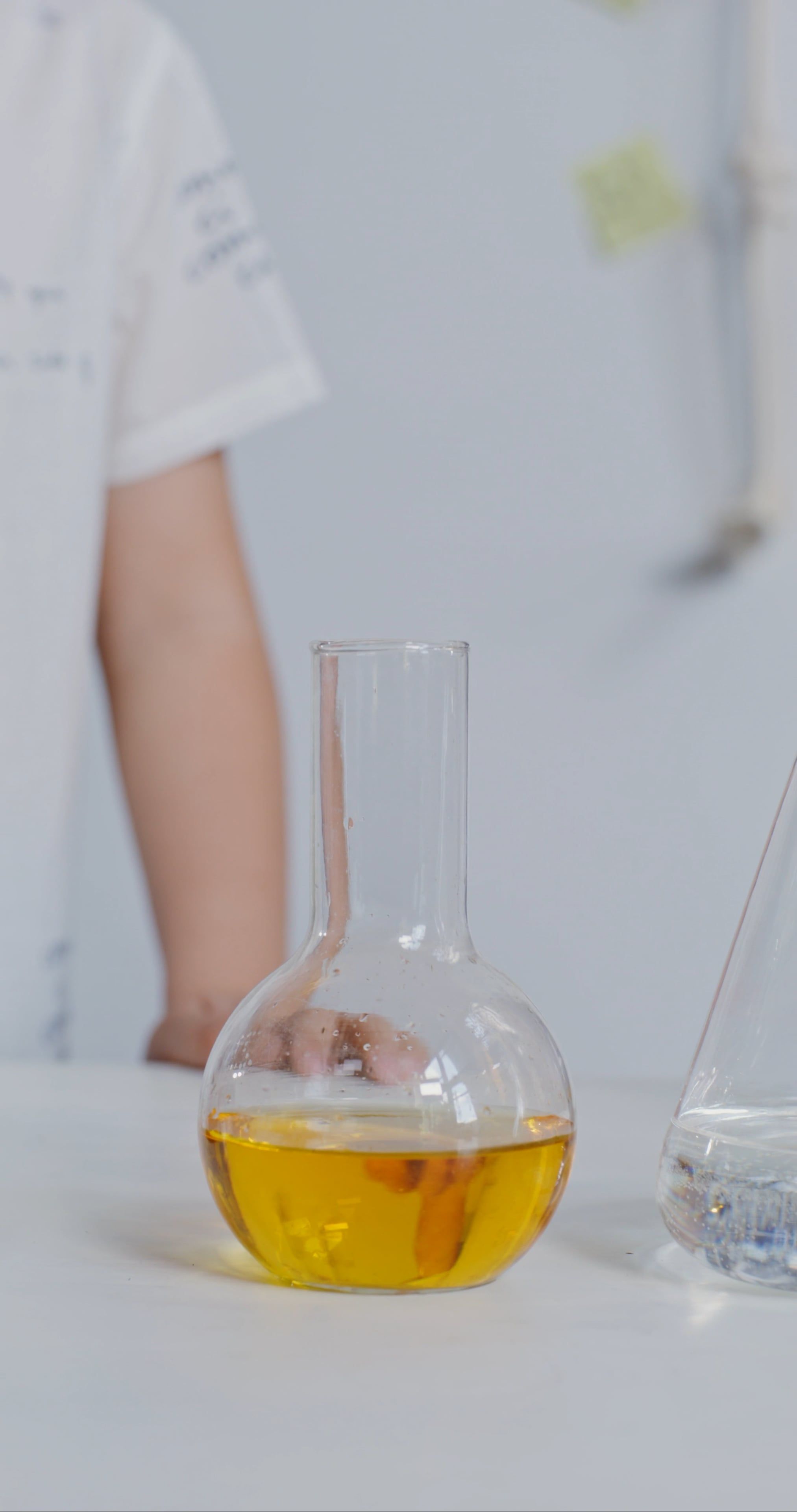A Person Pouring a Colored Liquid to a Florence Flask Free Stock Video ...