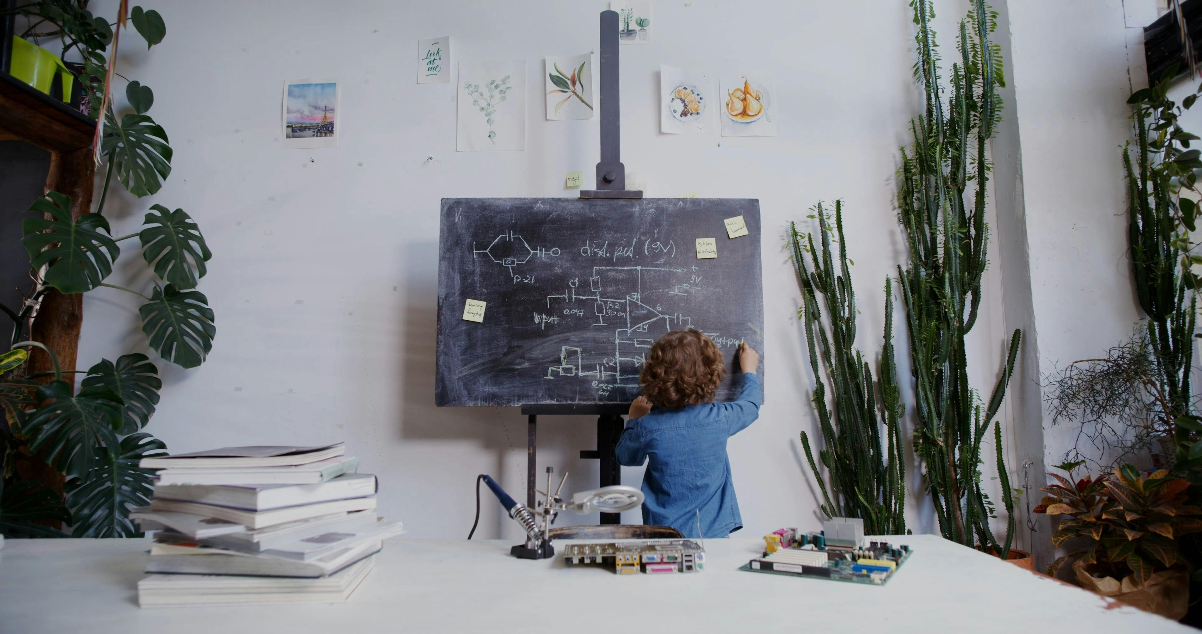 Boy Writing On a Chalkboard · Free Stock Video
