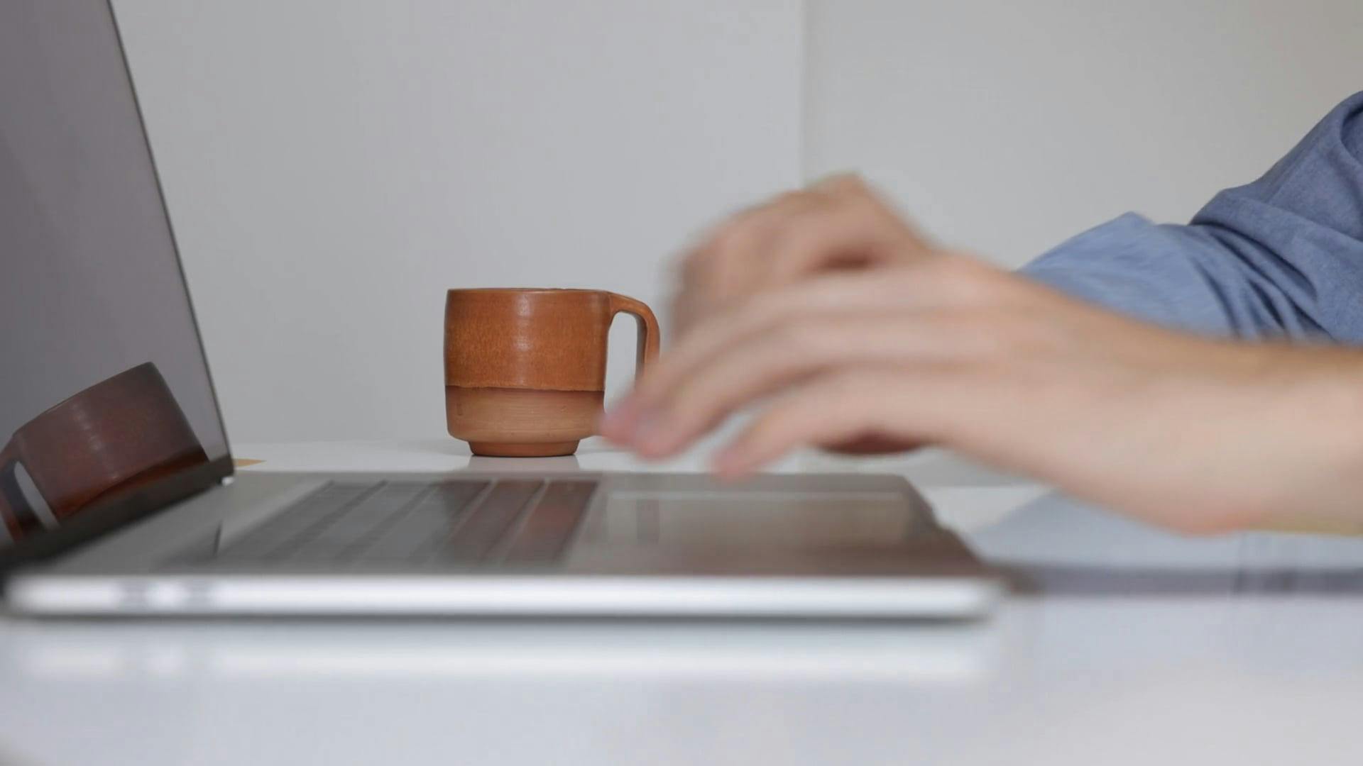 A Person Typing on Laptop while Pouring Coffee Free Stock Video Footage ...