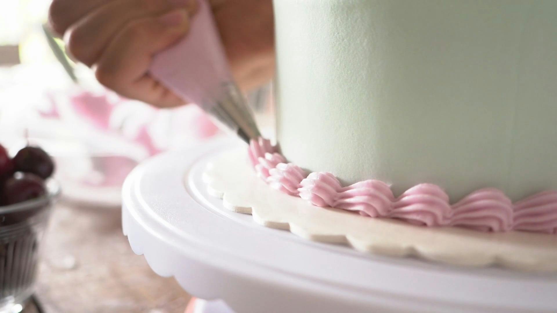Close up of a Person Placing Icing on a Cake · Free Stock Video