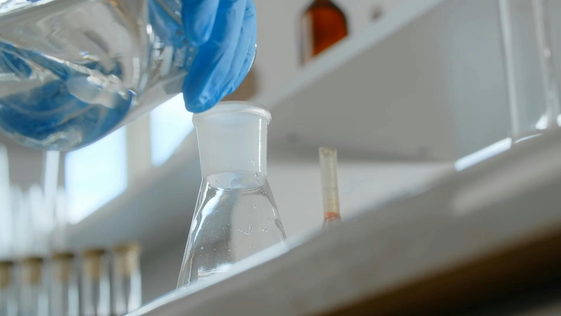 A Person Pouring Liquid in the Flask · Free Stock Video