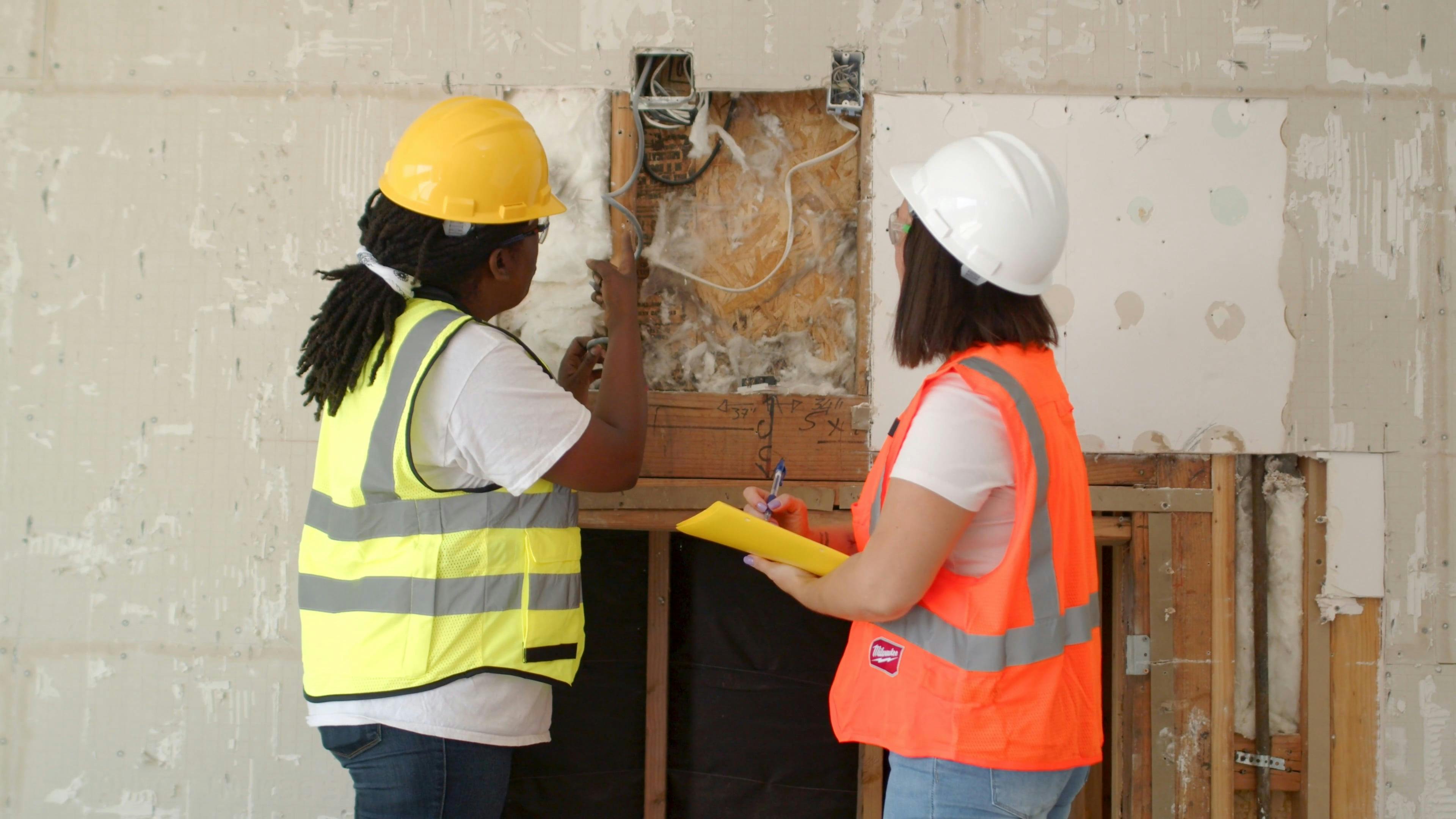 A Man Helping a Female Coworker at a Construction Site Free Stock Video ...