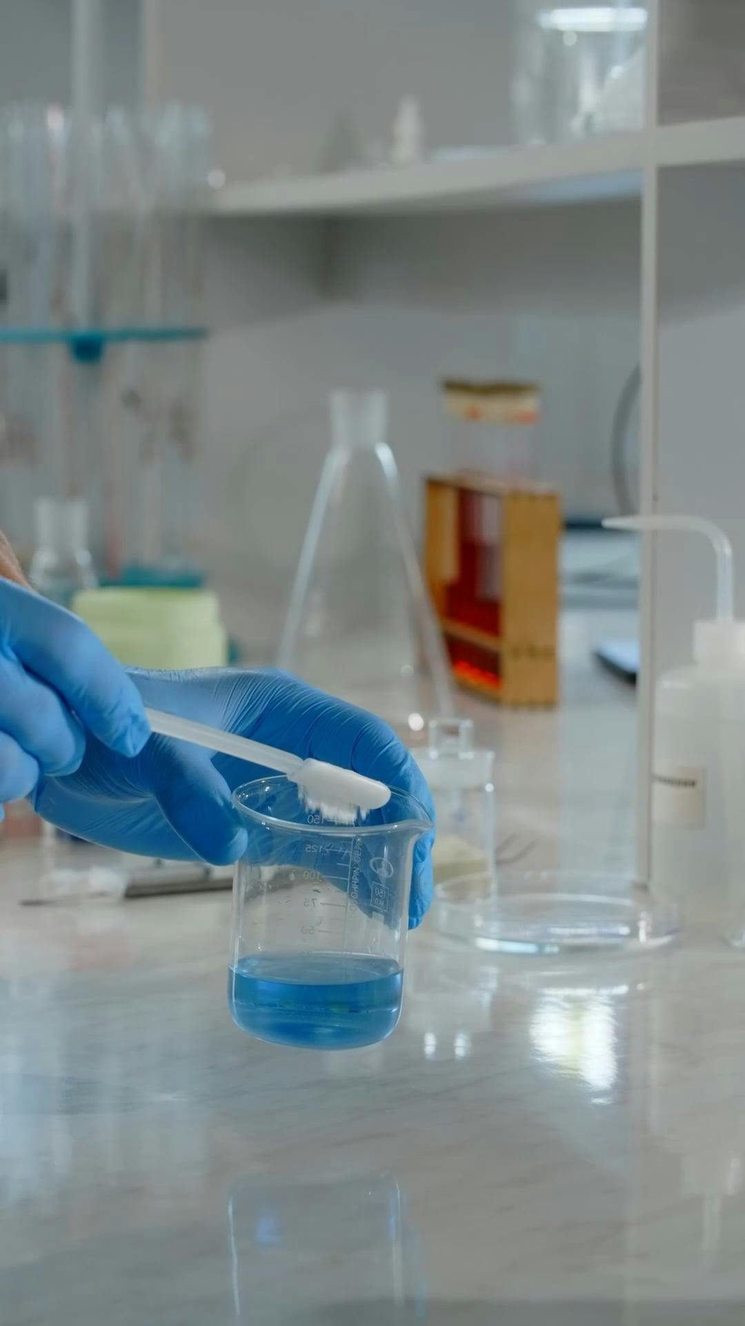 A Scientist Placing Powder into a Chemical in a Beaker Free Stock Video ...