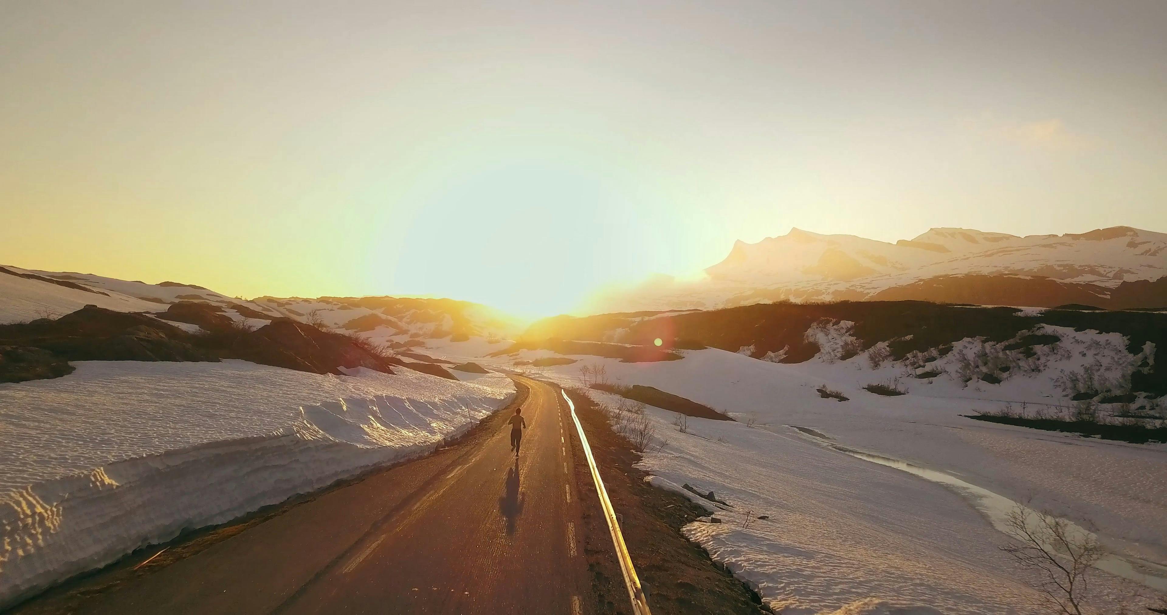 Aerial Shot of a Man Running on Mountain Road · Free Stock Video