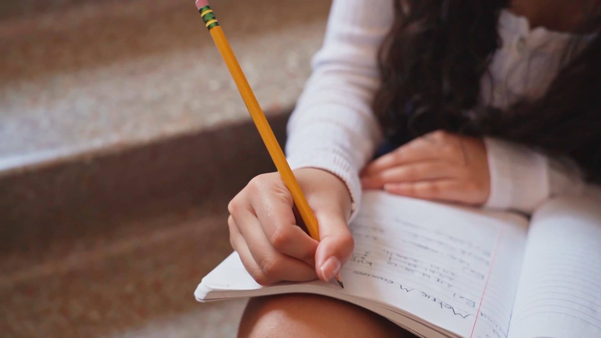 Student Writing on a Notebook · Free Stock Video