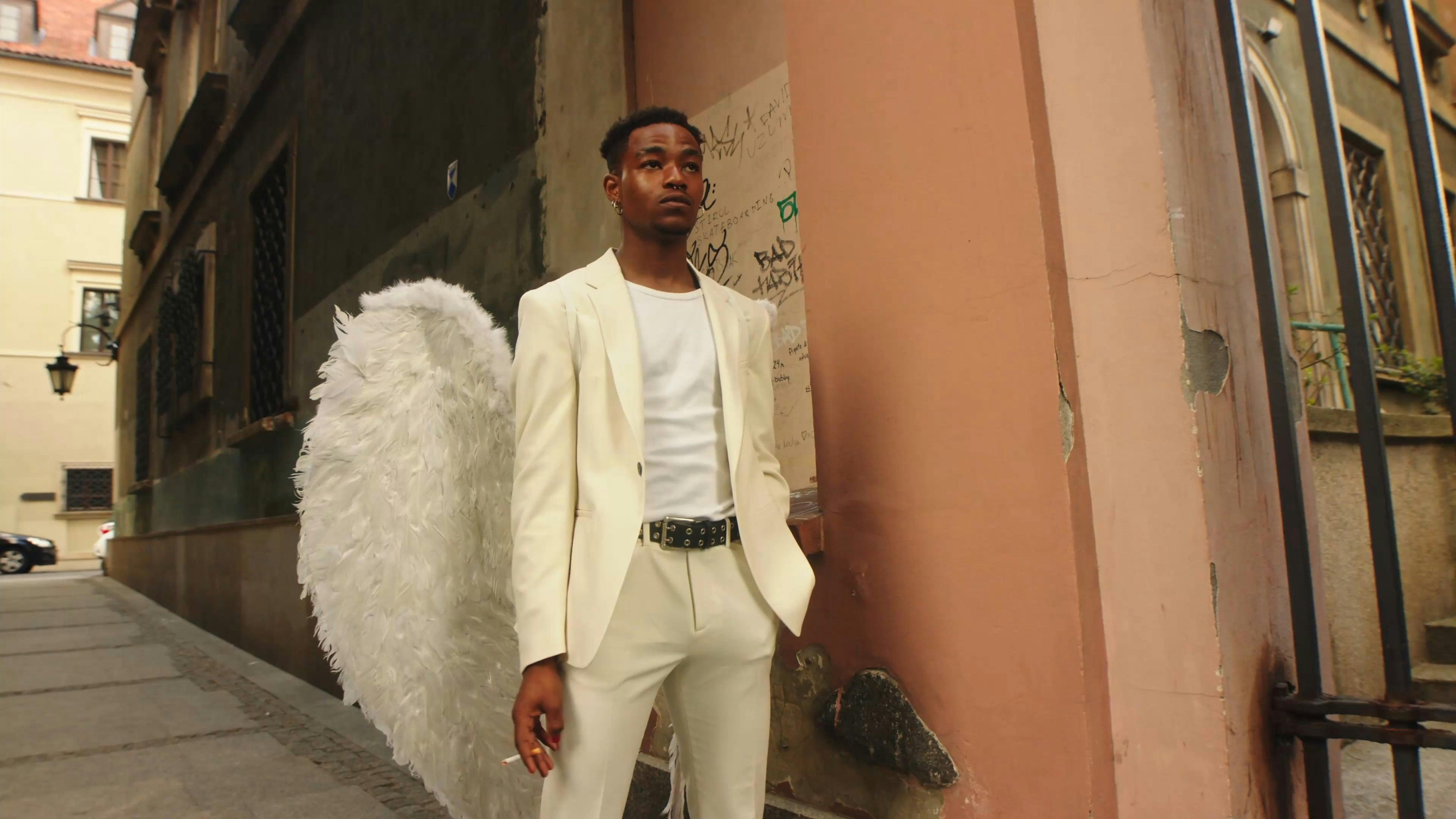 An Angel Sitting on the Rooftop Ledge · Free Stock Video