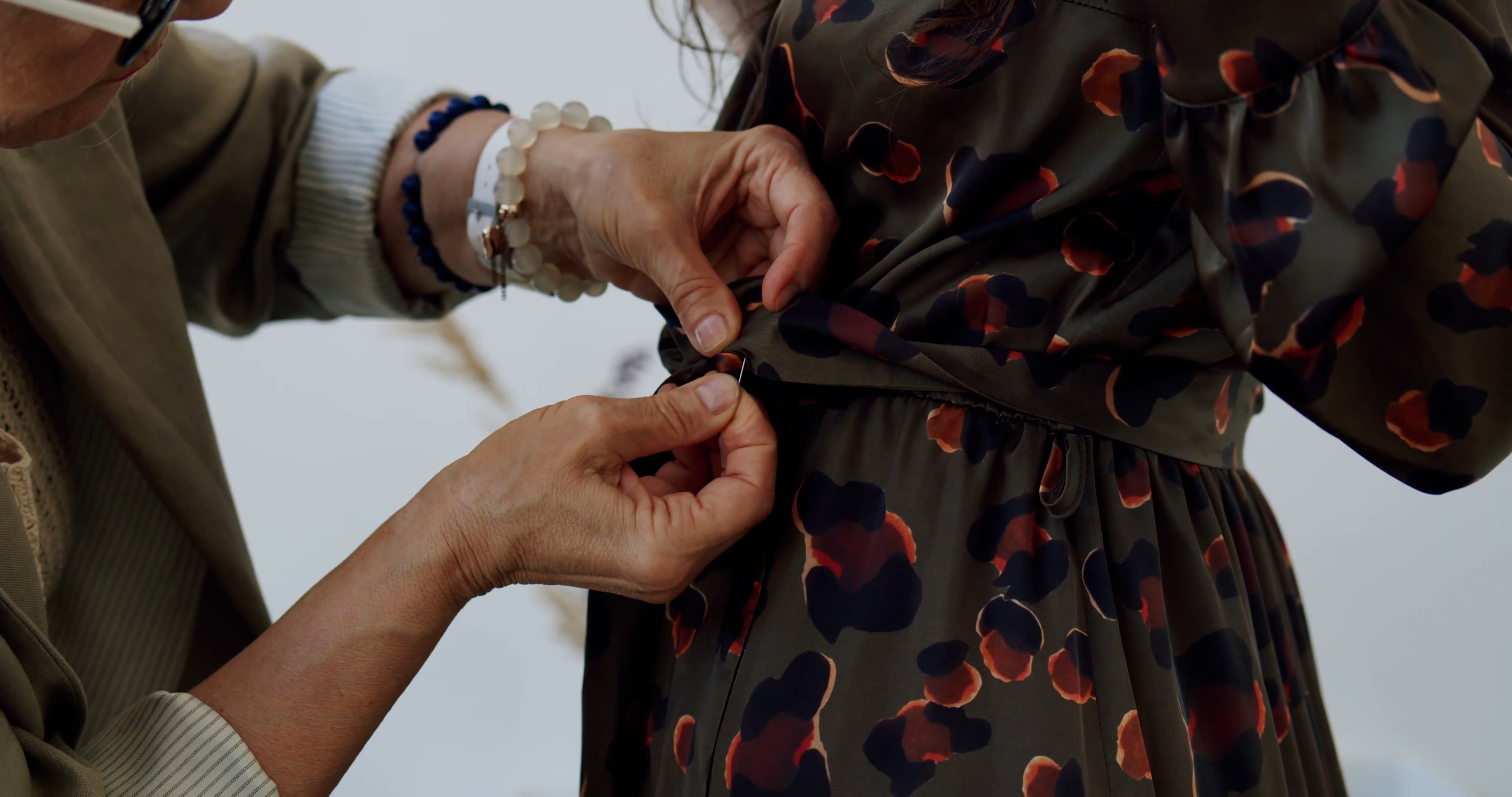 An Elderly Woman Pinning a Woman's Dress Free Stock Video Footage ...