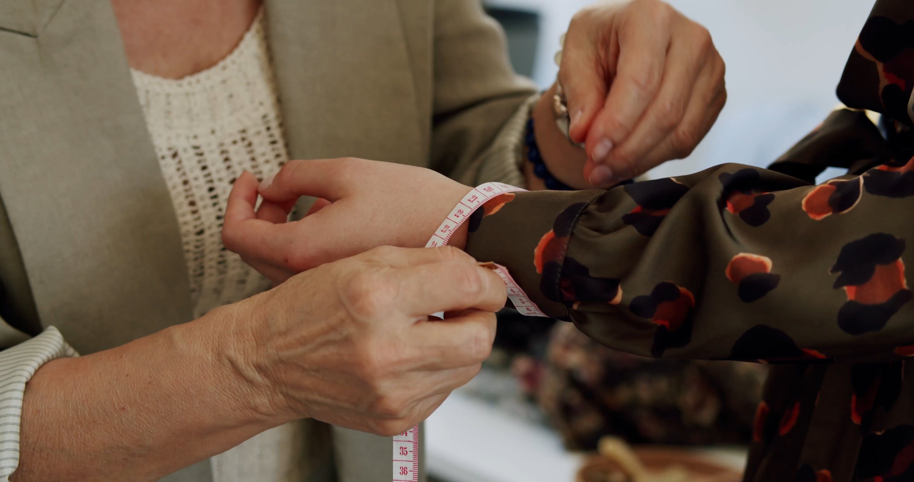An Elderly Woman Measuring a Client's Wrist · Free Stock Video