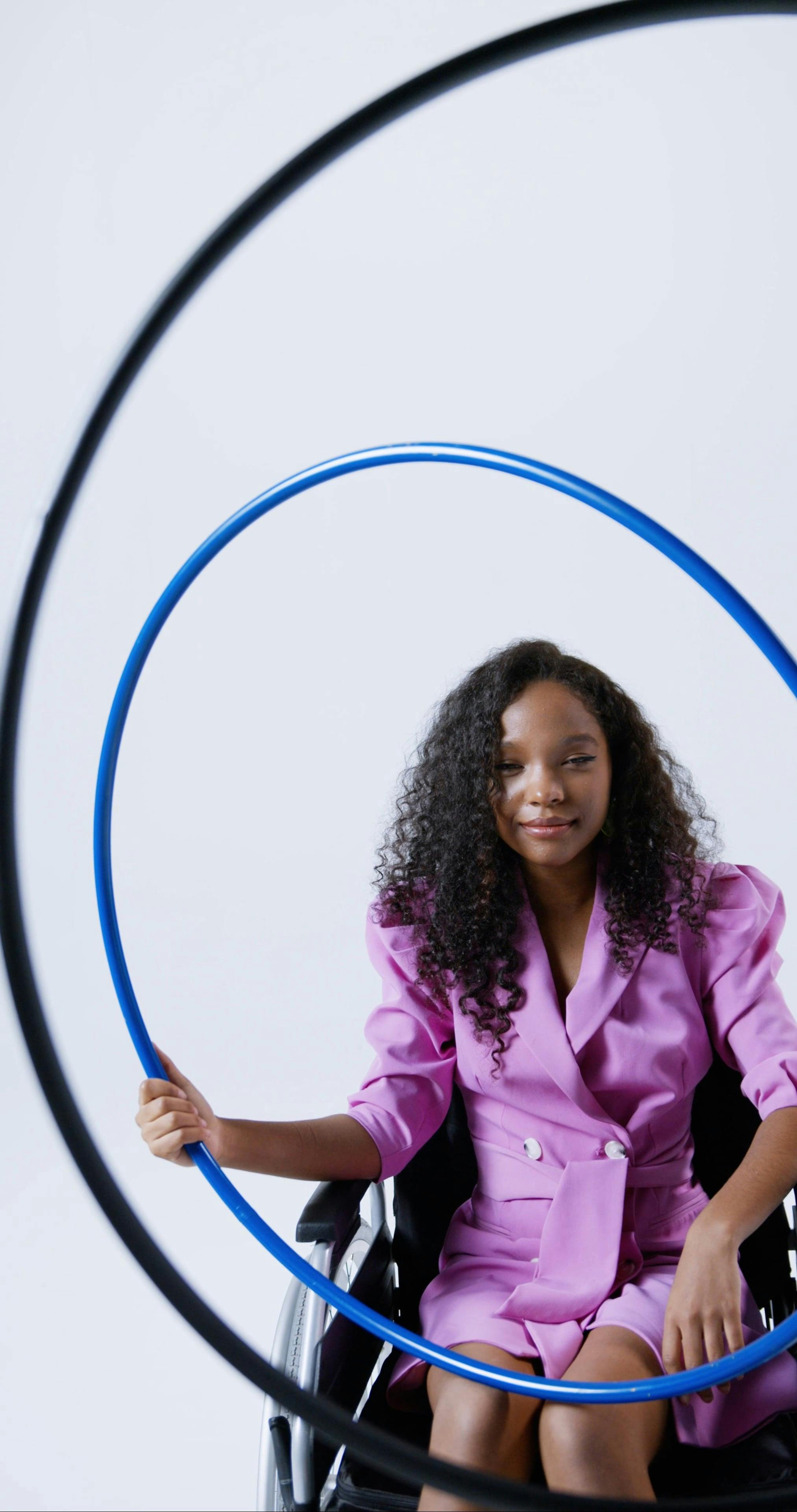 A Woman Holding a Hula Hoop While Looking at Camera · Free Stock Video