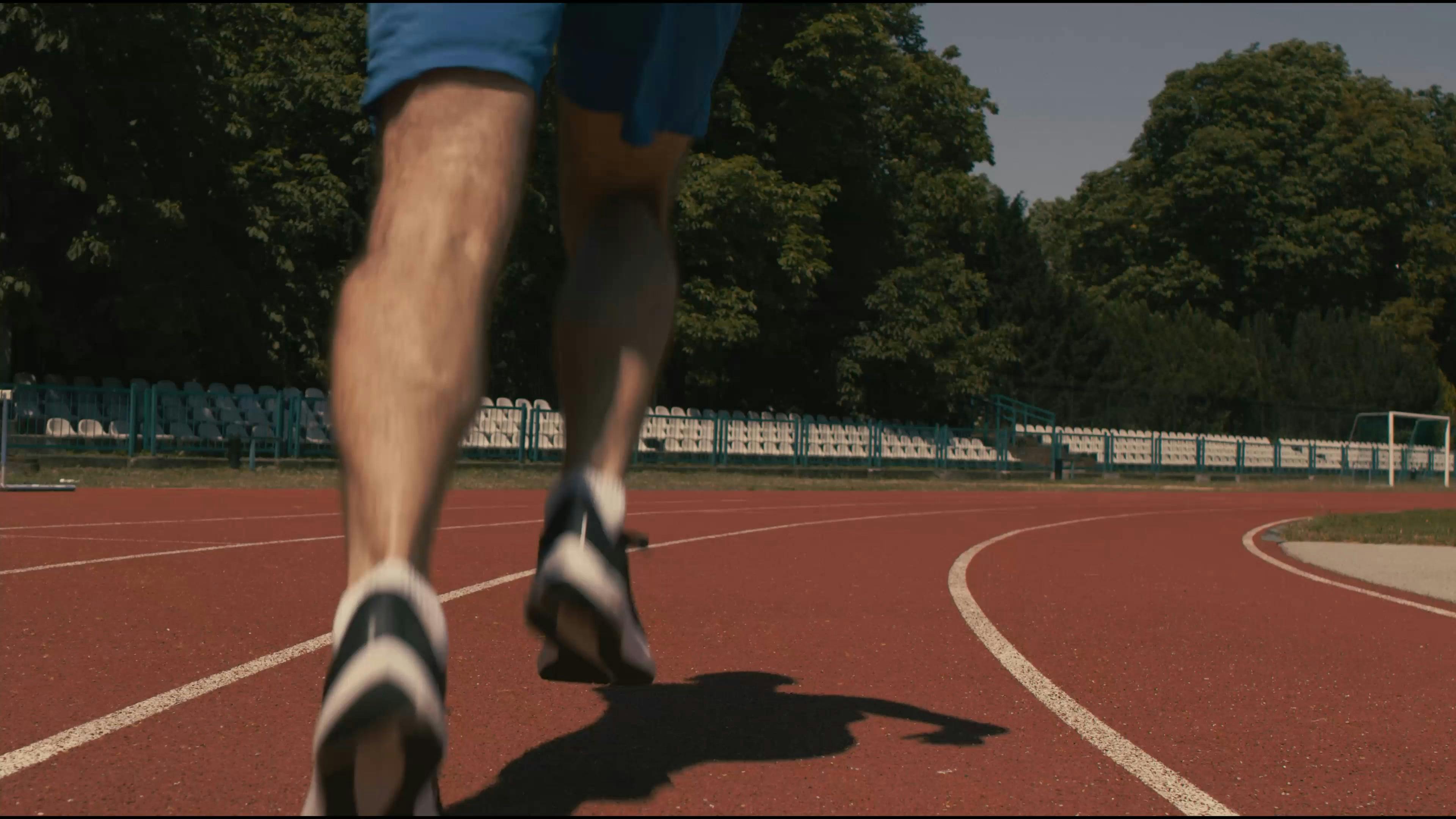 Knee Level Shot of a Man Running at a Track · Free Stock Video