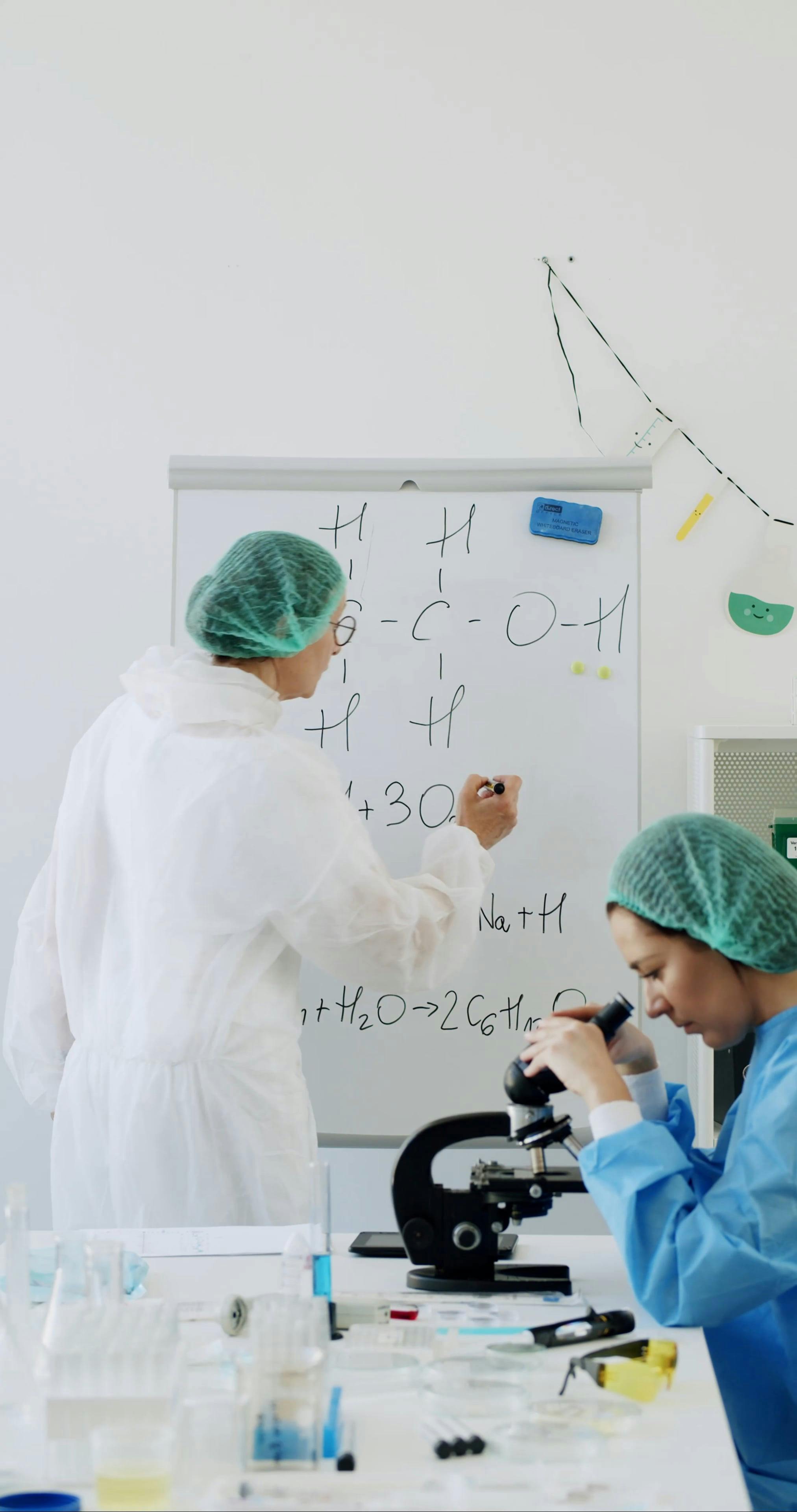 Female Scientists Looking at a Microscope · Free Stock Video