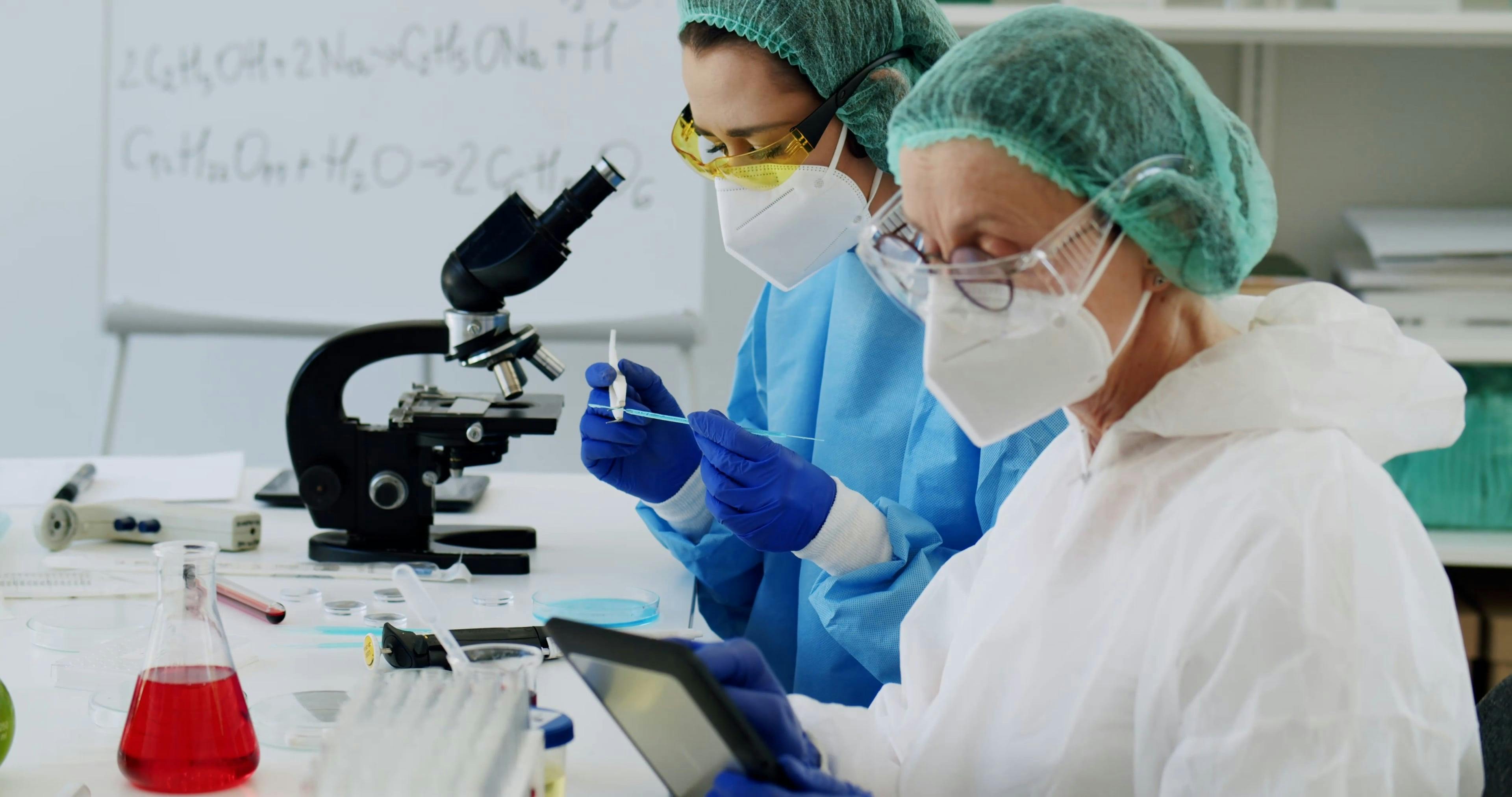 Women in PPE Working in the Laboratory · Free Stock Video