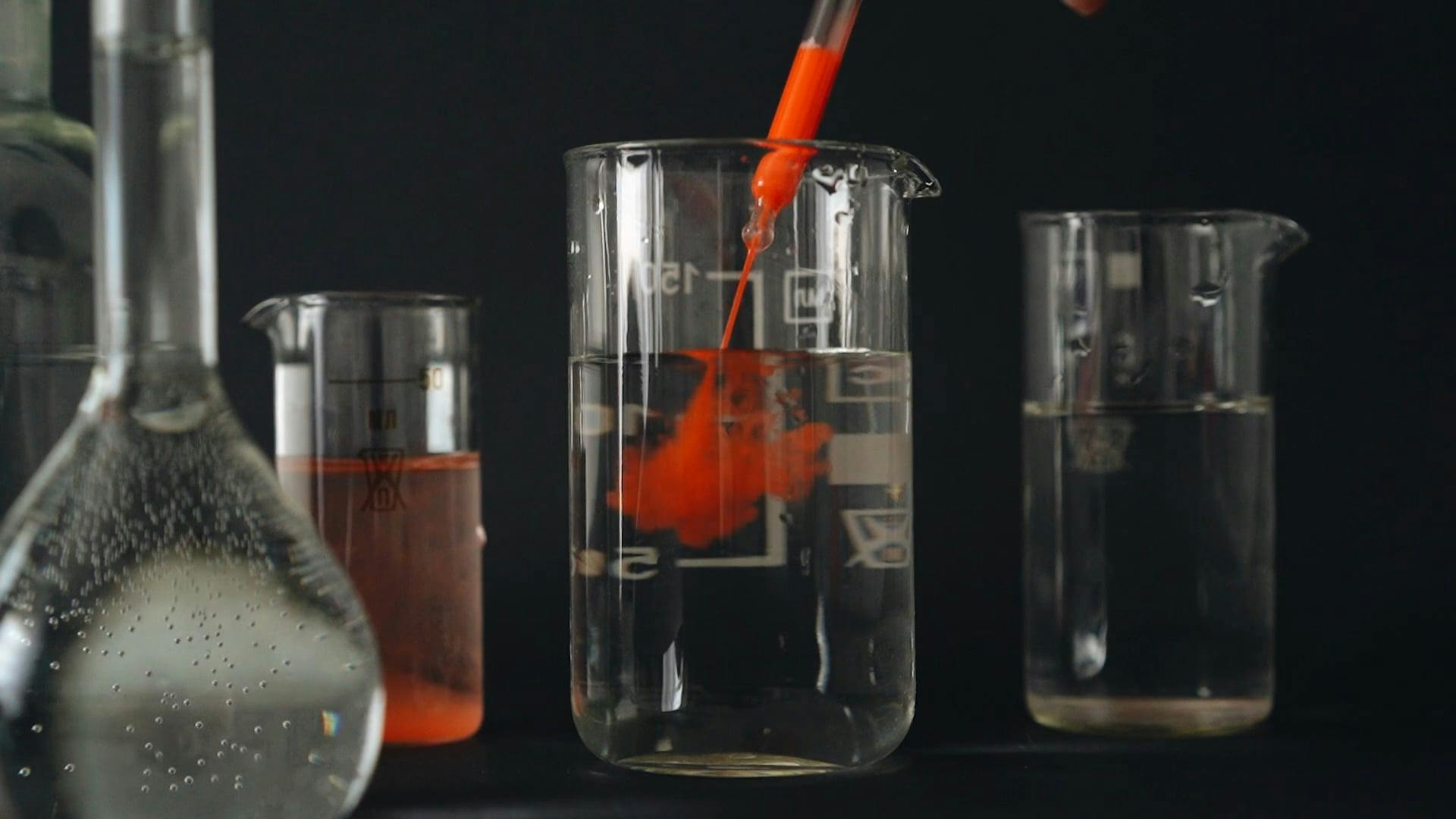A Man Pouring Liquid from a Beaker · Free Stock Video