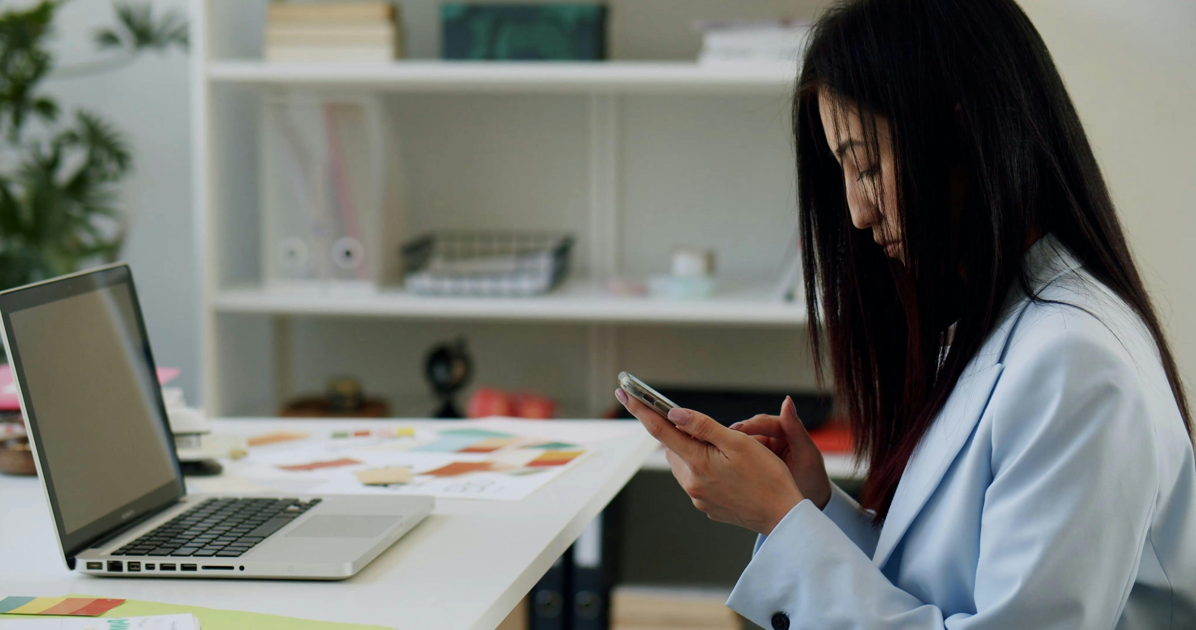 A Woman Using her Cellphone at Work · Free Stock Video