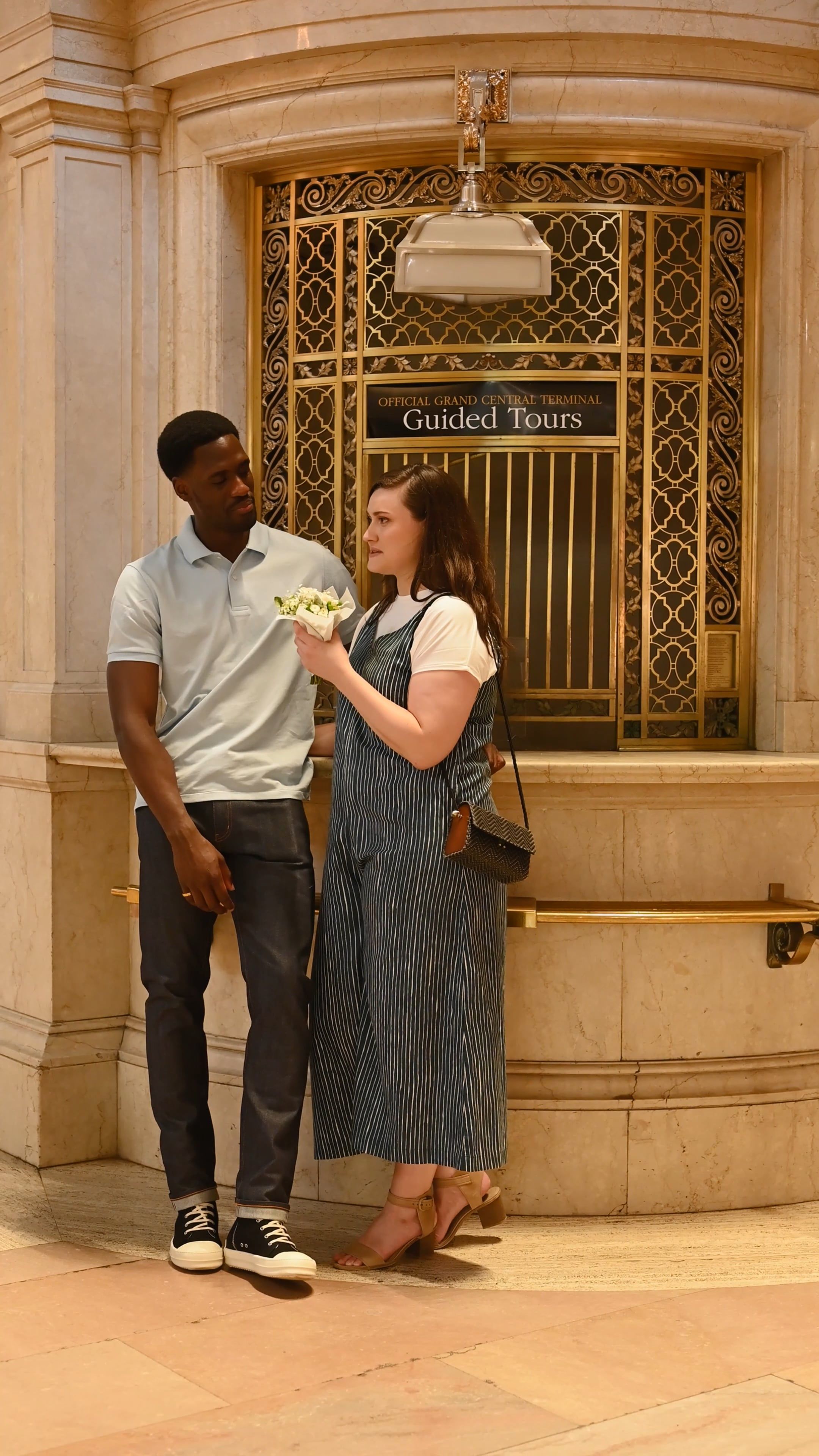 A Man and a Woman Talking beside a Guided Tours Booth · Free Stock Video