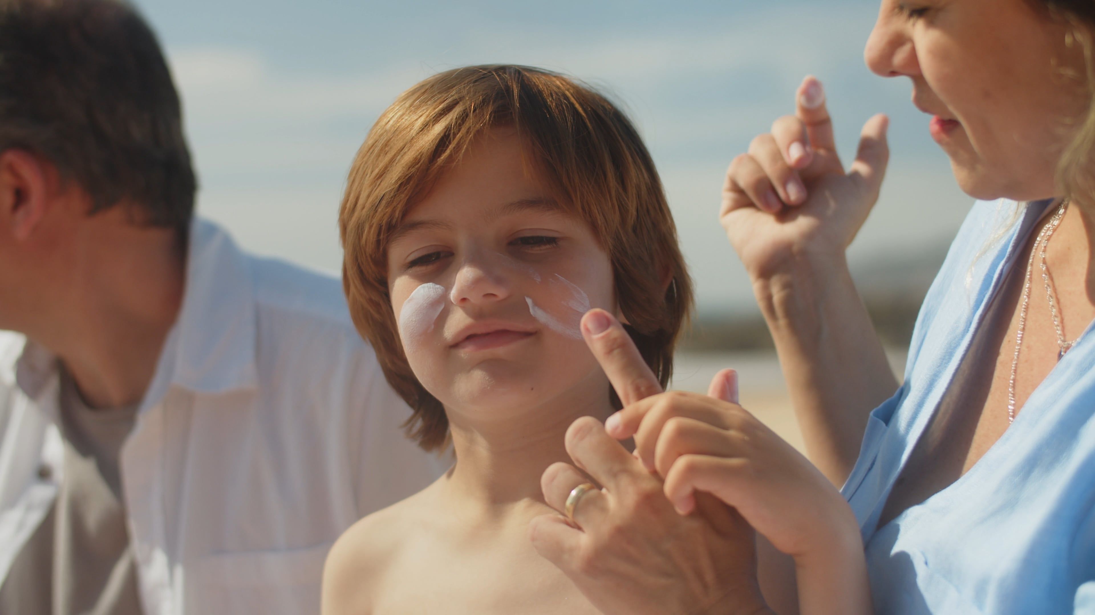 A Woman Putting Sunblock on Her Son's Face Free Stock Video Footage ...