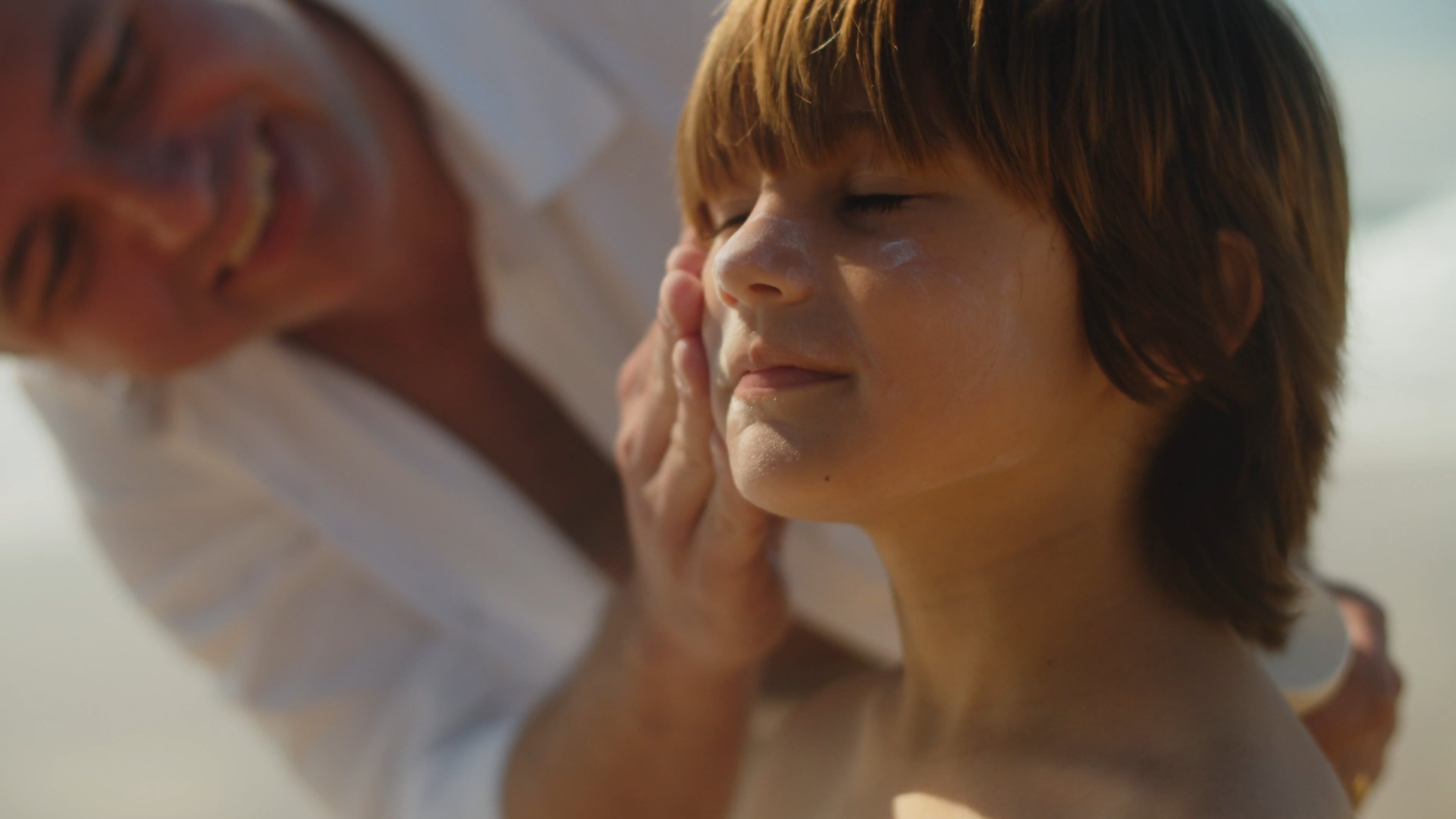 Father Putting Sunblock on His Son's Face Free Stock Video Footage ...