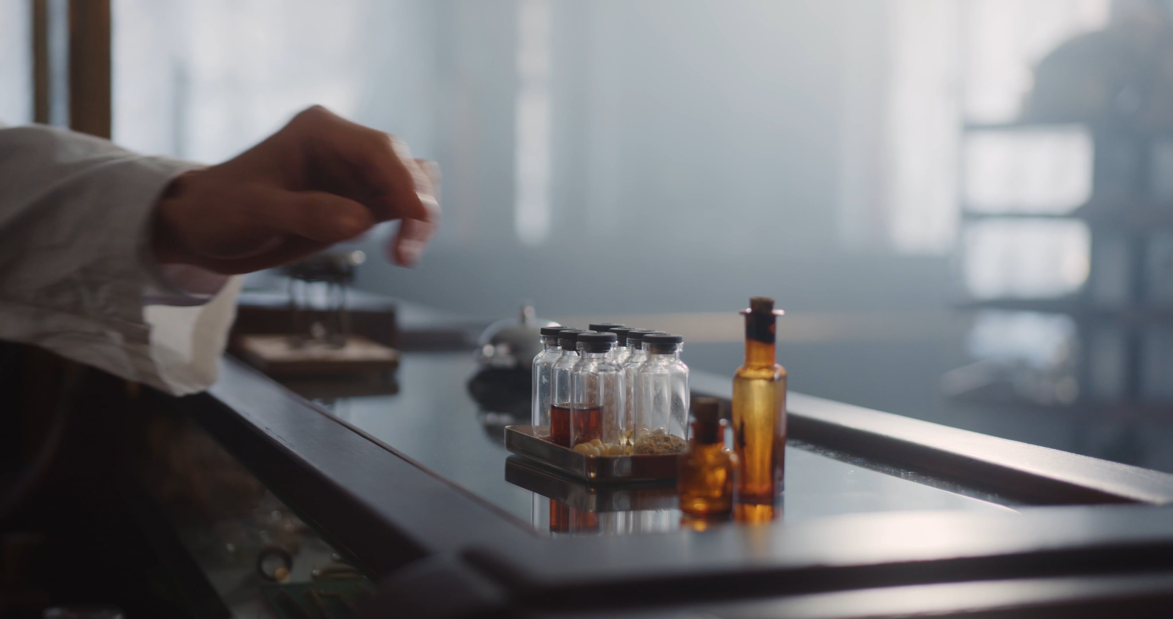 A Person Getting a Tiny Glass Bottle on a Rack Free Stock Video Footage ...