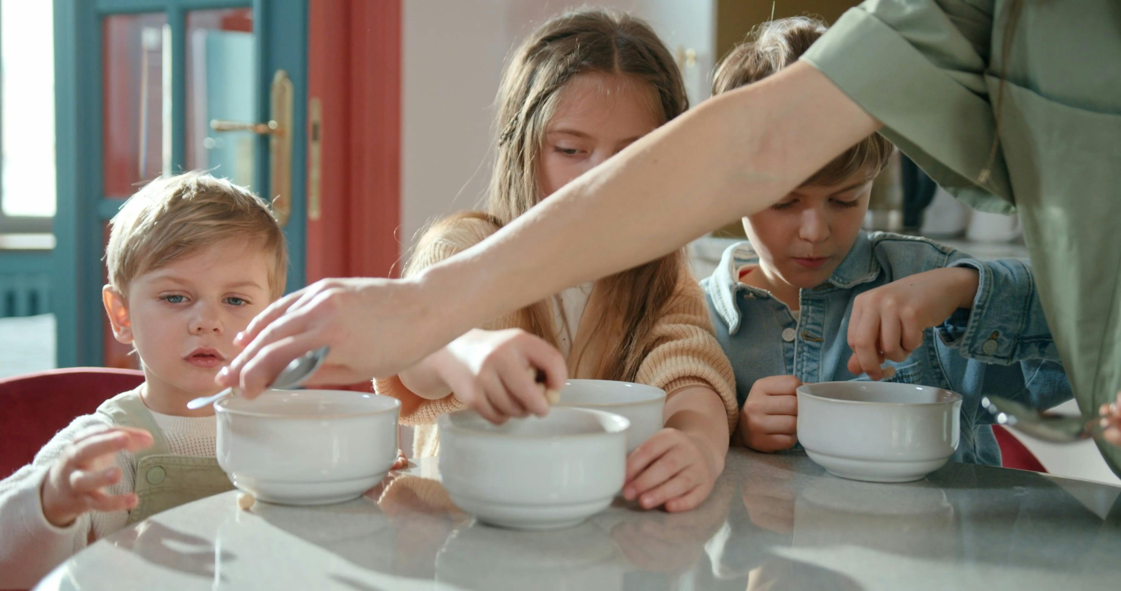 Kids Putting Cereal on Their Bowls · Free Stock Video