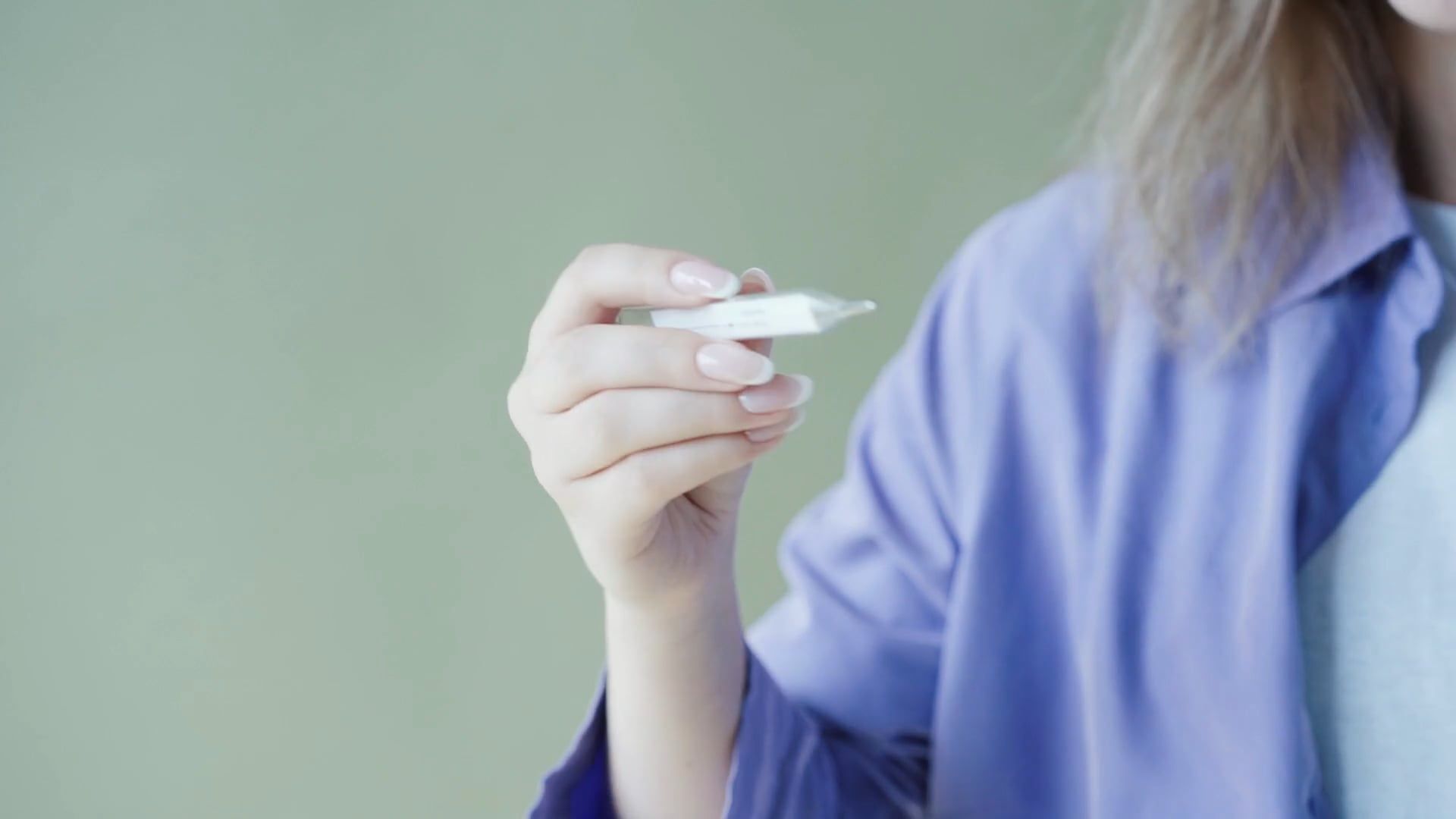 Woman Checking Her Body Temperature With A Thermometer Free Stock Video