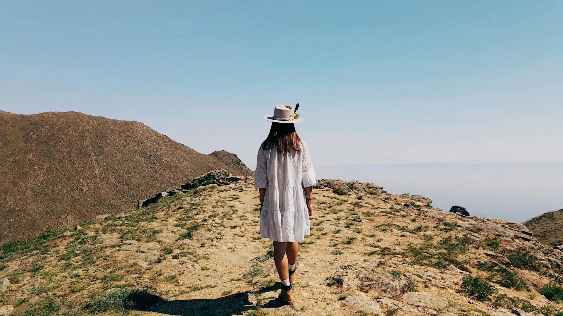 A Drone Footage of a Woman Walking on Top of the Mountain Free Stock ...