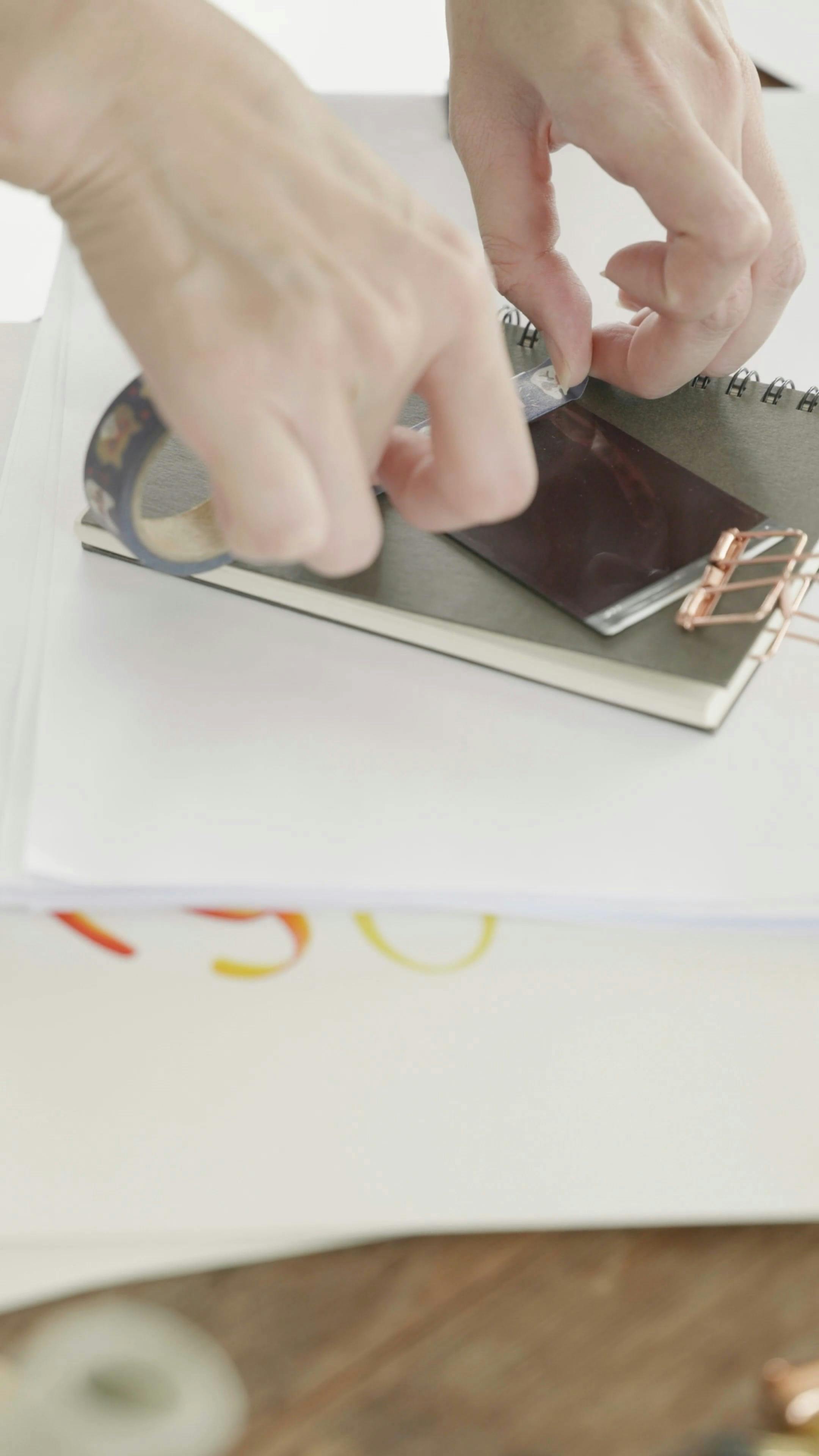 Person Sticking Photo on a Notebook Free Stock Video Footage, Royalty ...