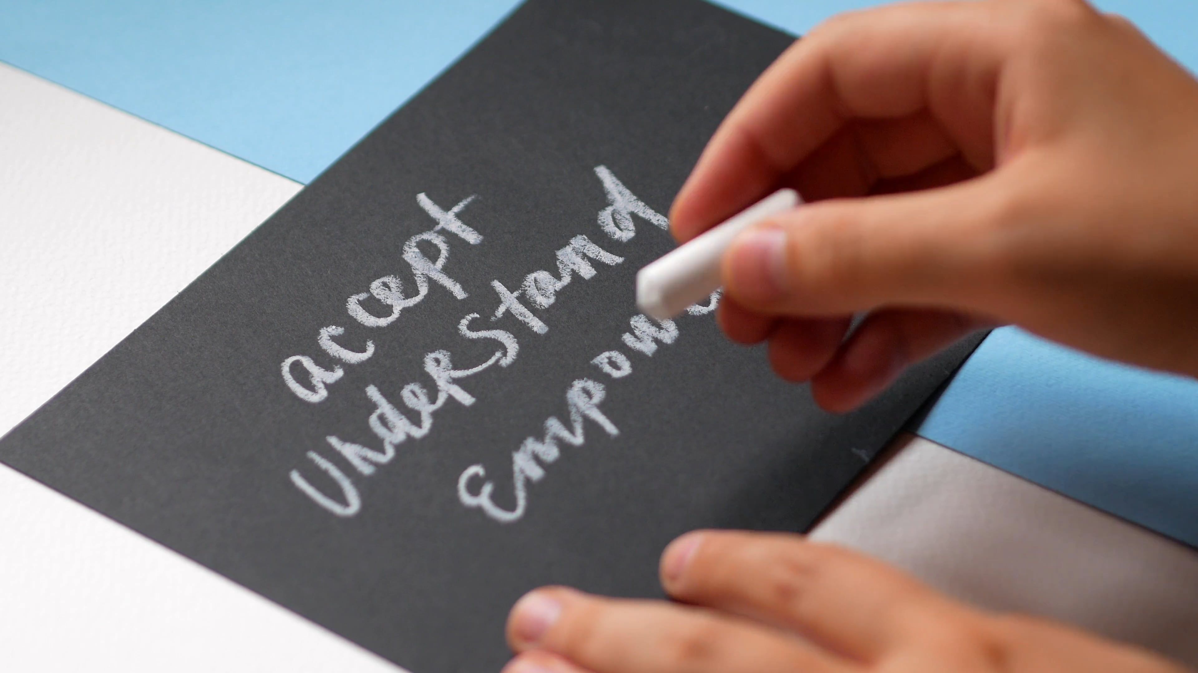 Person Writing on a Black Paper · Free Stock Video