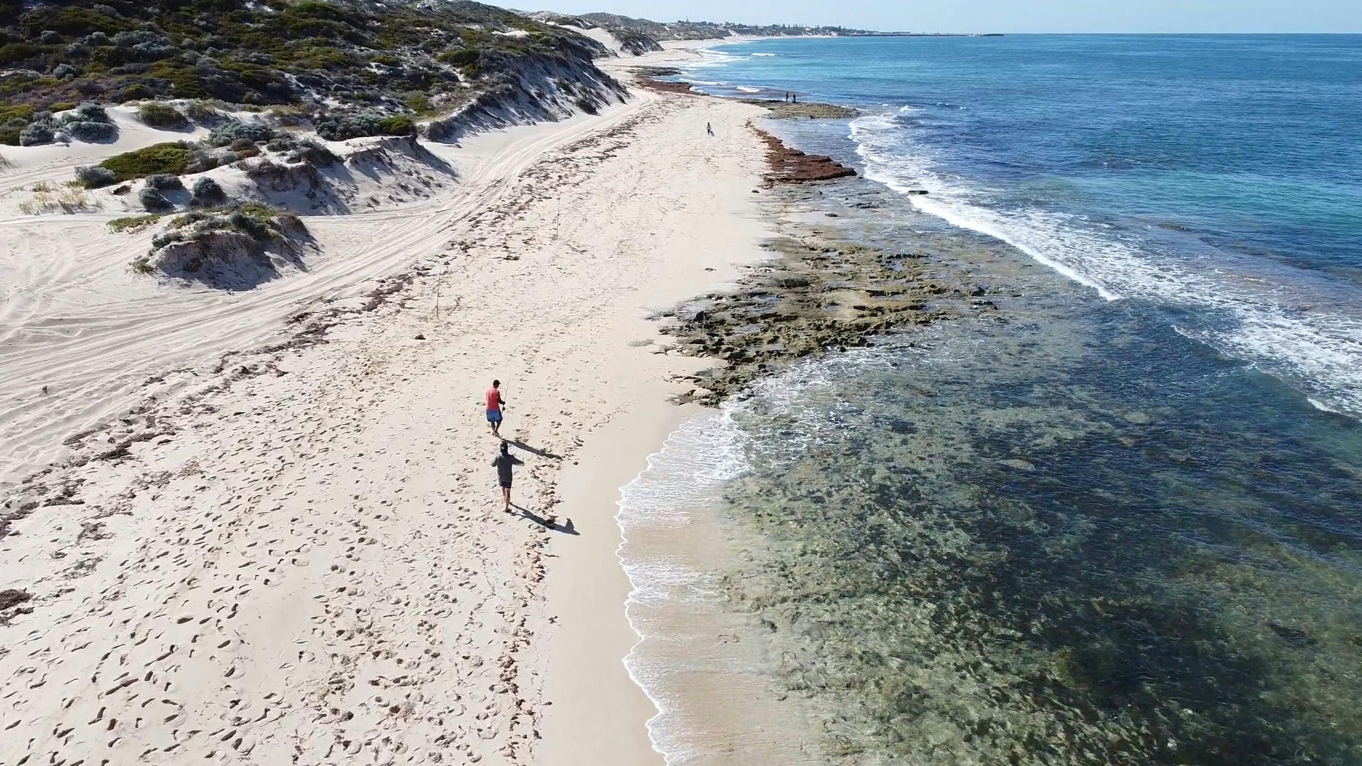Couple Walking on a Beach Filmed with a Drone Free Stock Video Footage ...