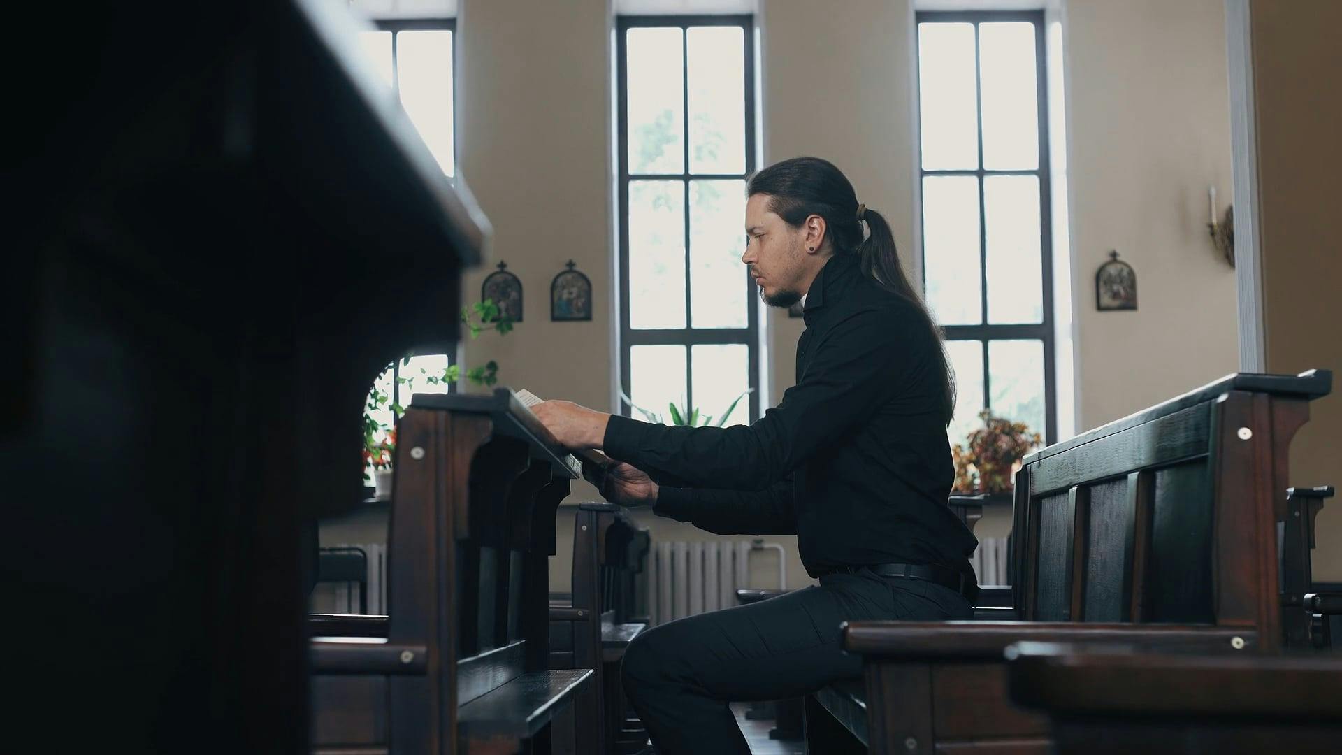 A Man Sitting on a Pew while Reading Bible Free Stock Video Footage ...
