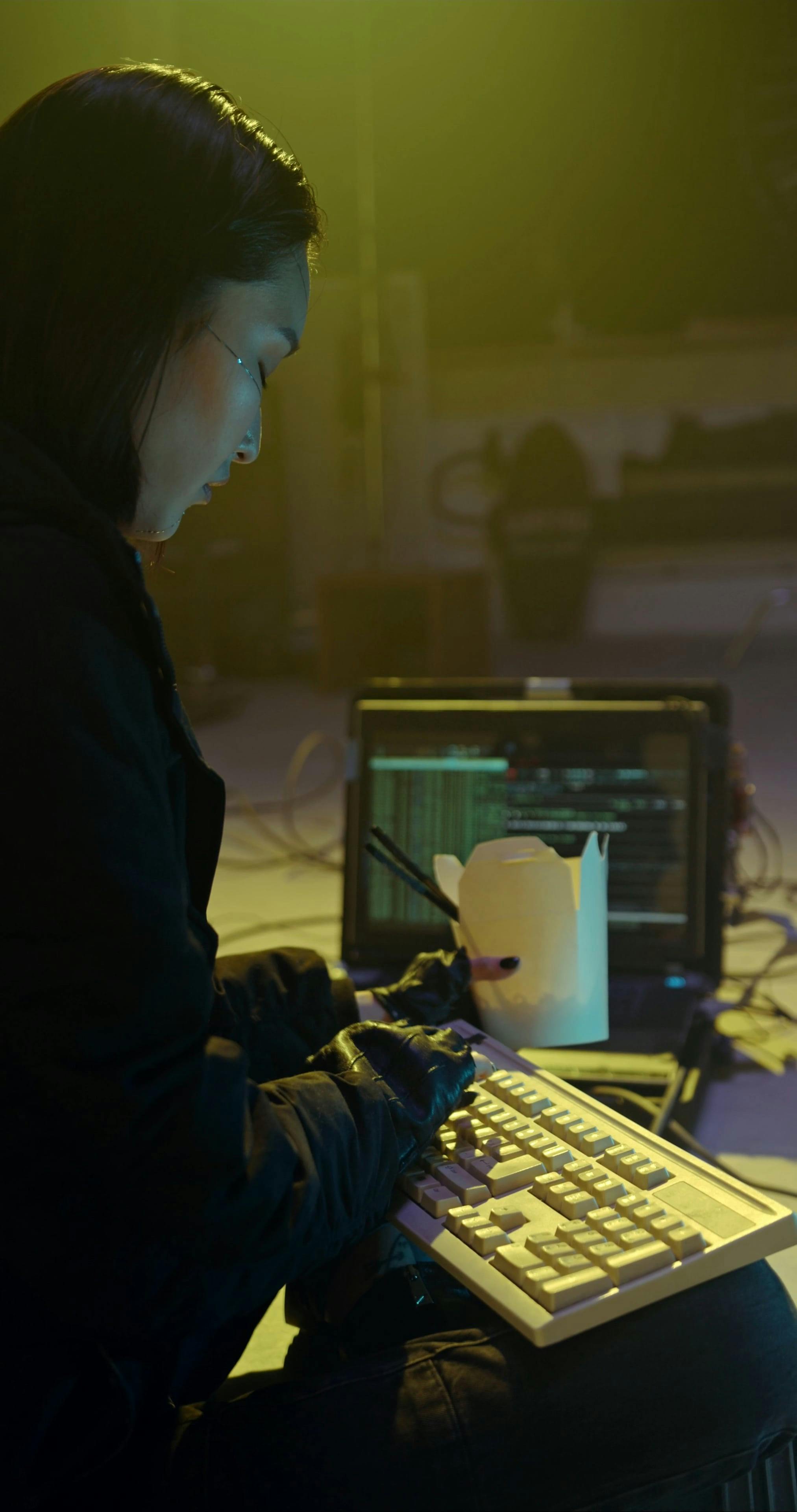 A Woman Typing on a Keyboard While Eating Noodles Free Stock Video ...
