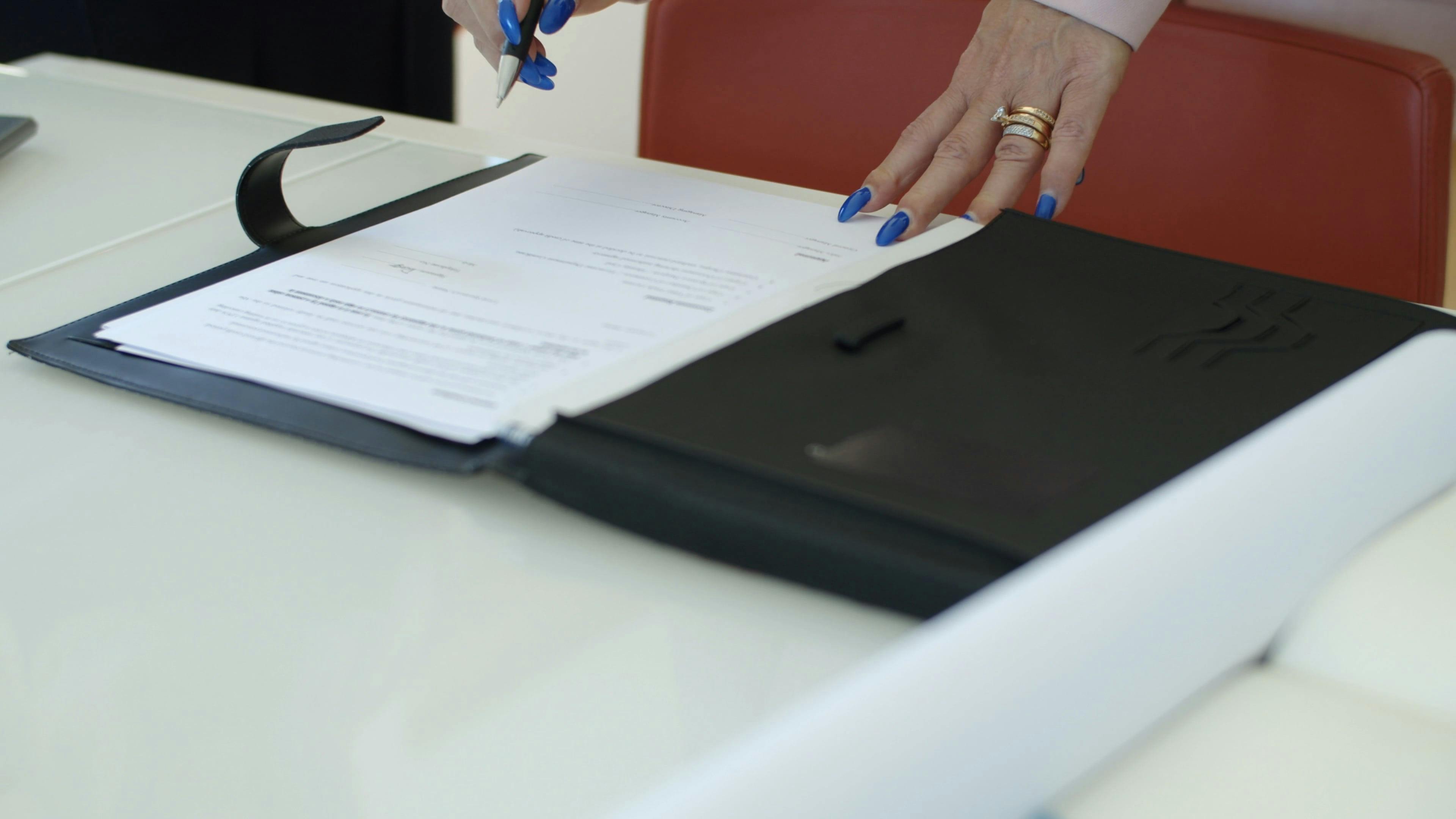 Person Signing a Document · Free Stock Video