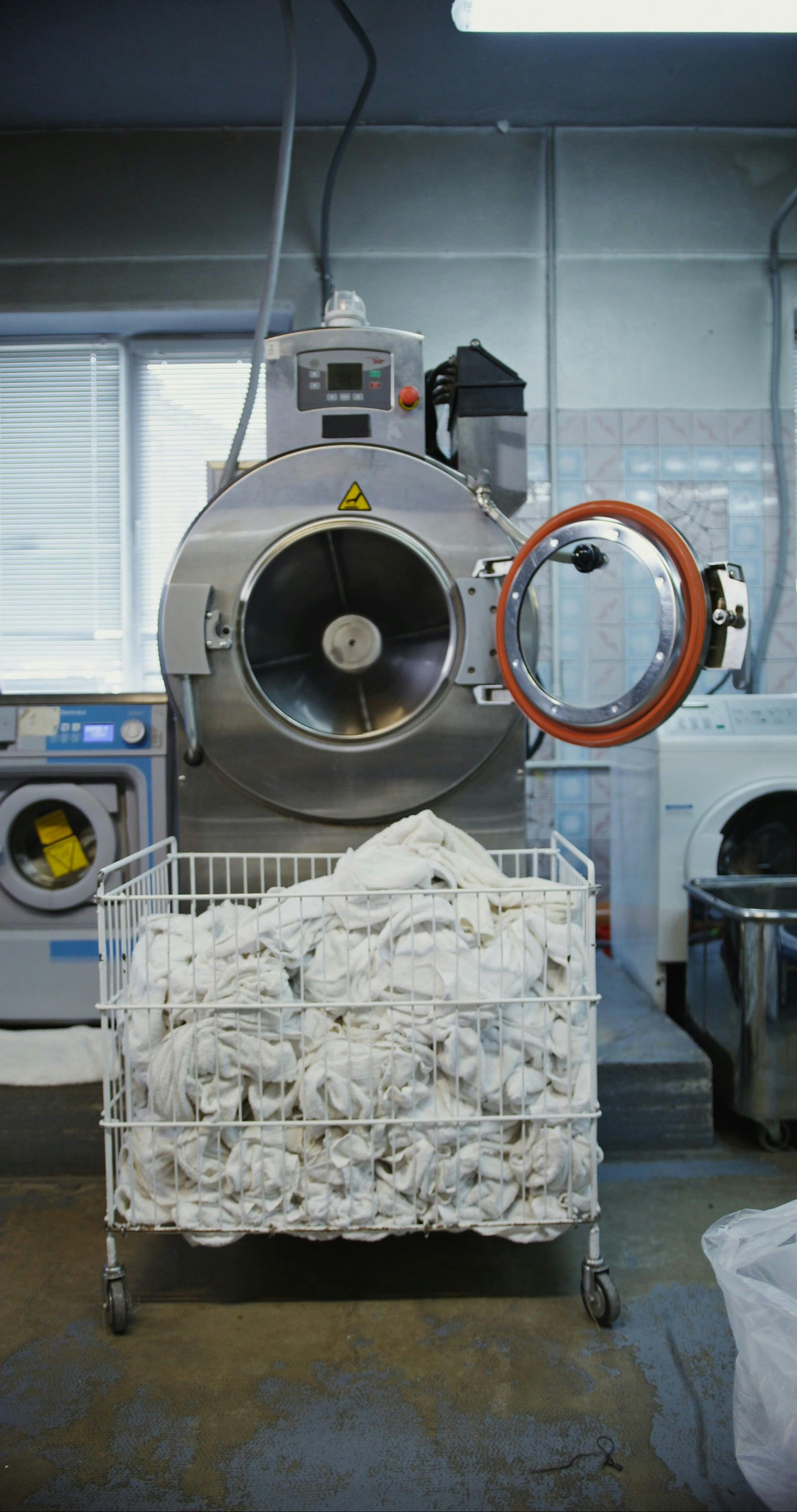 A Man Closing the Door of a Commercial Washing Machine Free Stock Video ...