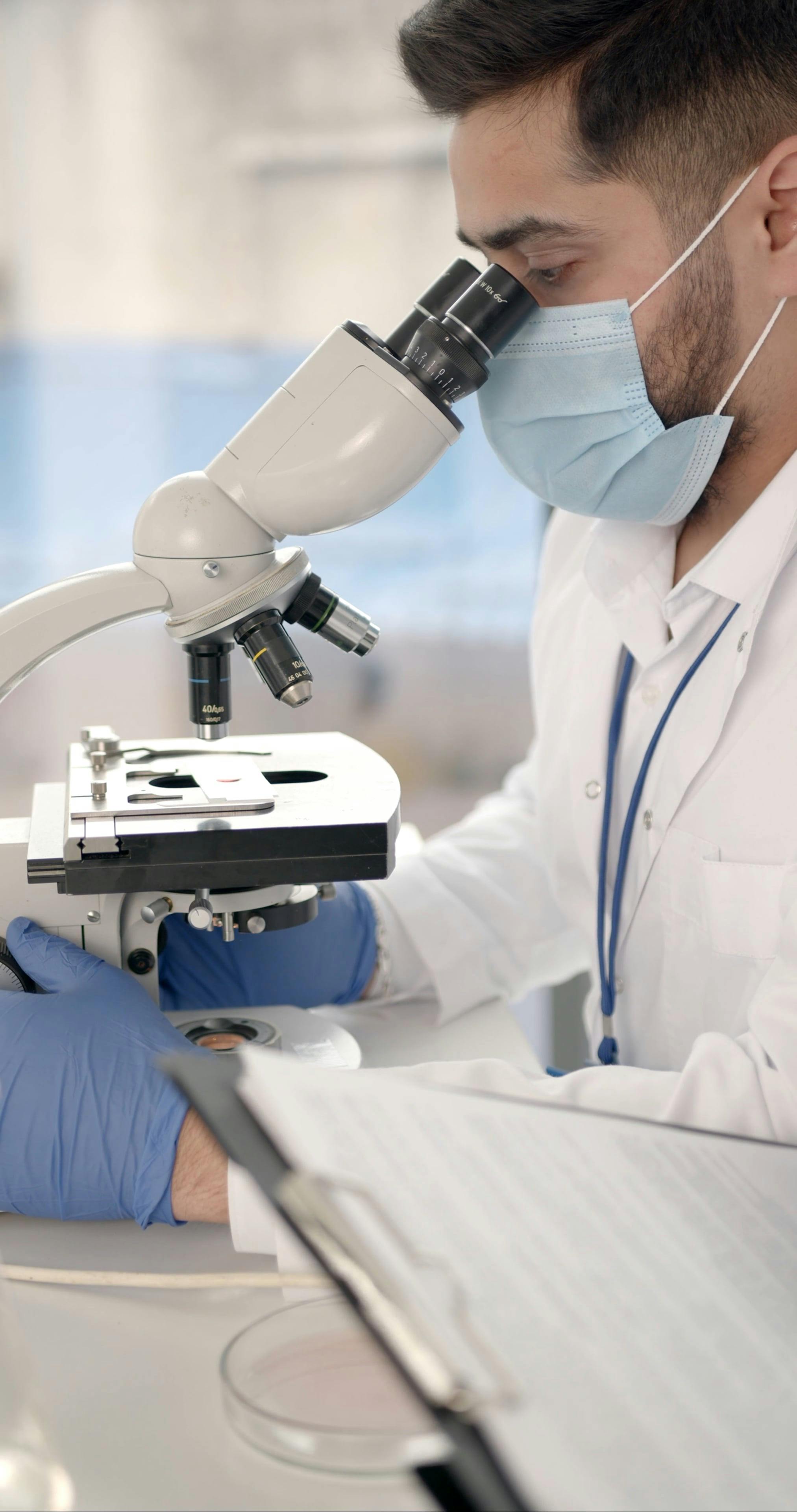 A Person Observing A Specimen Under A Microscope · Free Stock Video