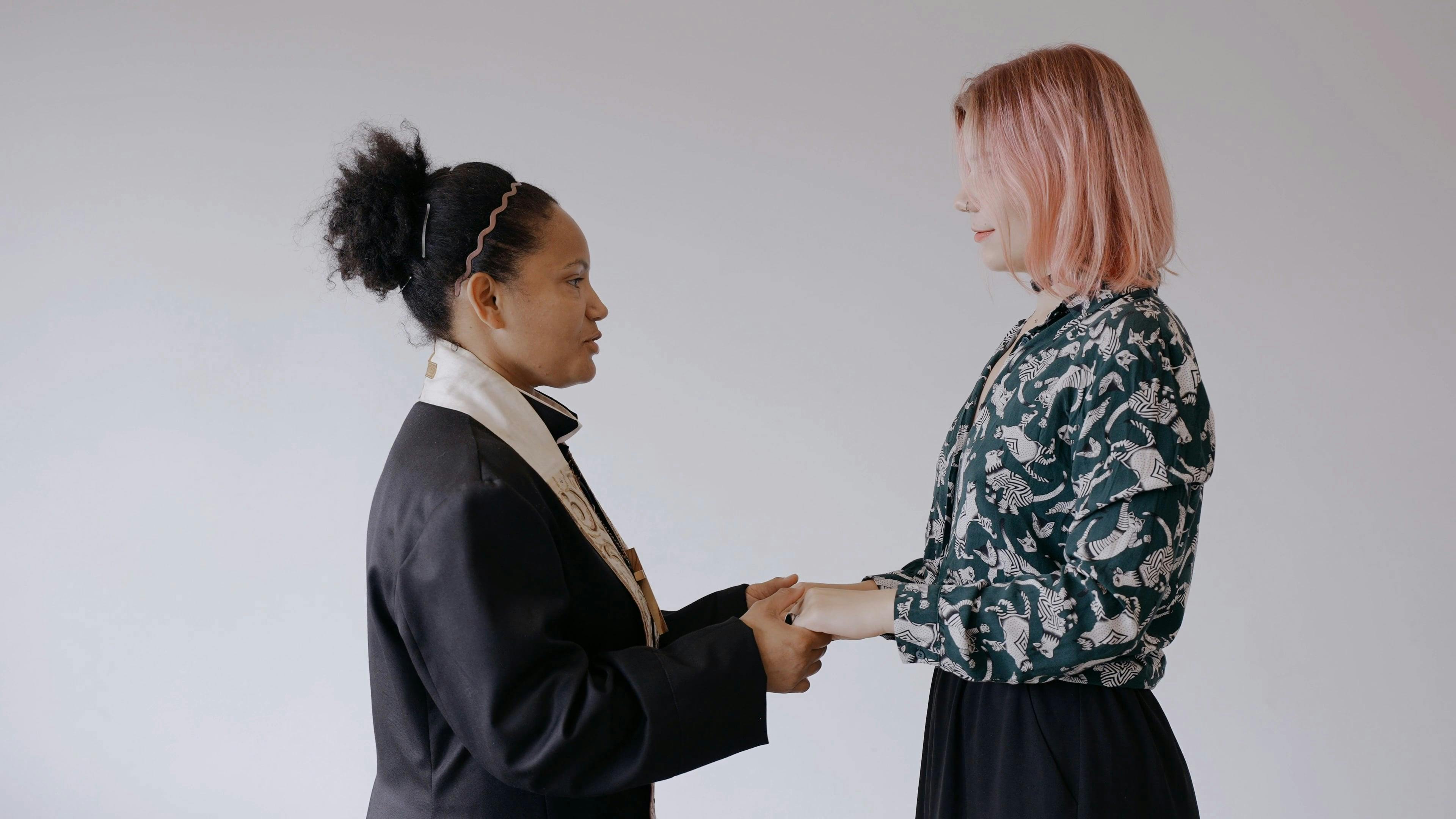 A Woman Pastor Talking to Parishioner while Holding Each Other's Hands ...
