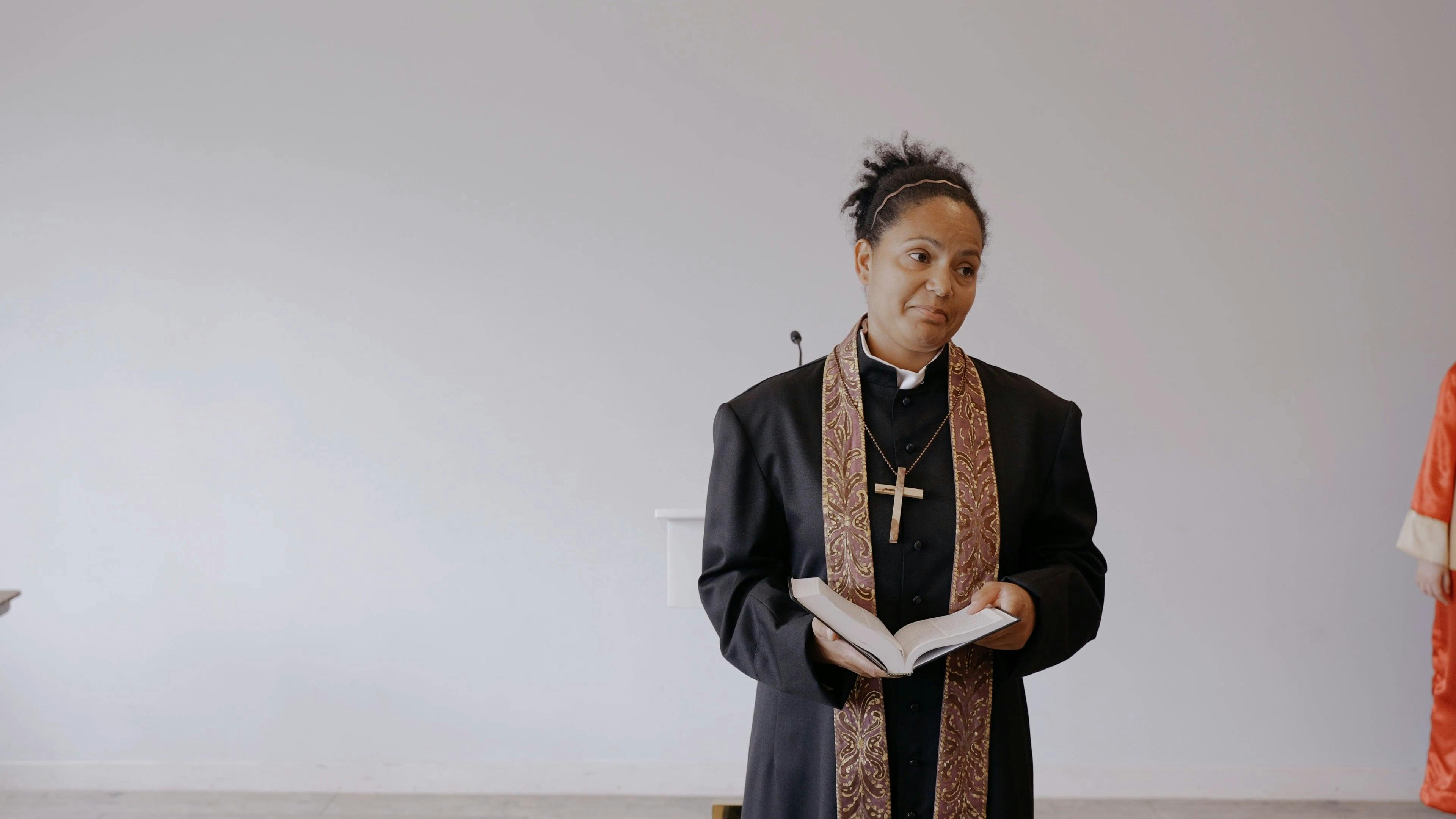 A Woman Pastor Talking while Holding a Bible · Free Stock Video