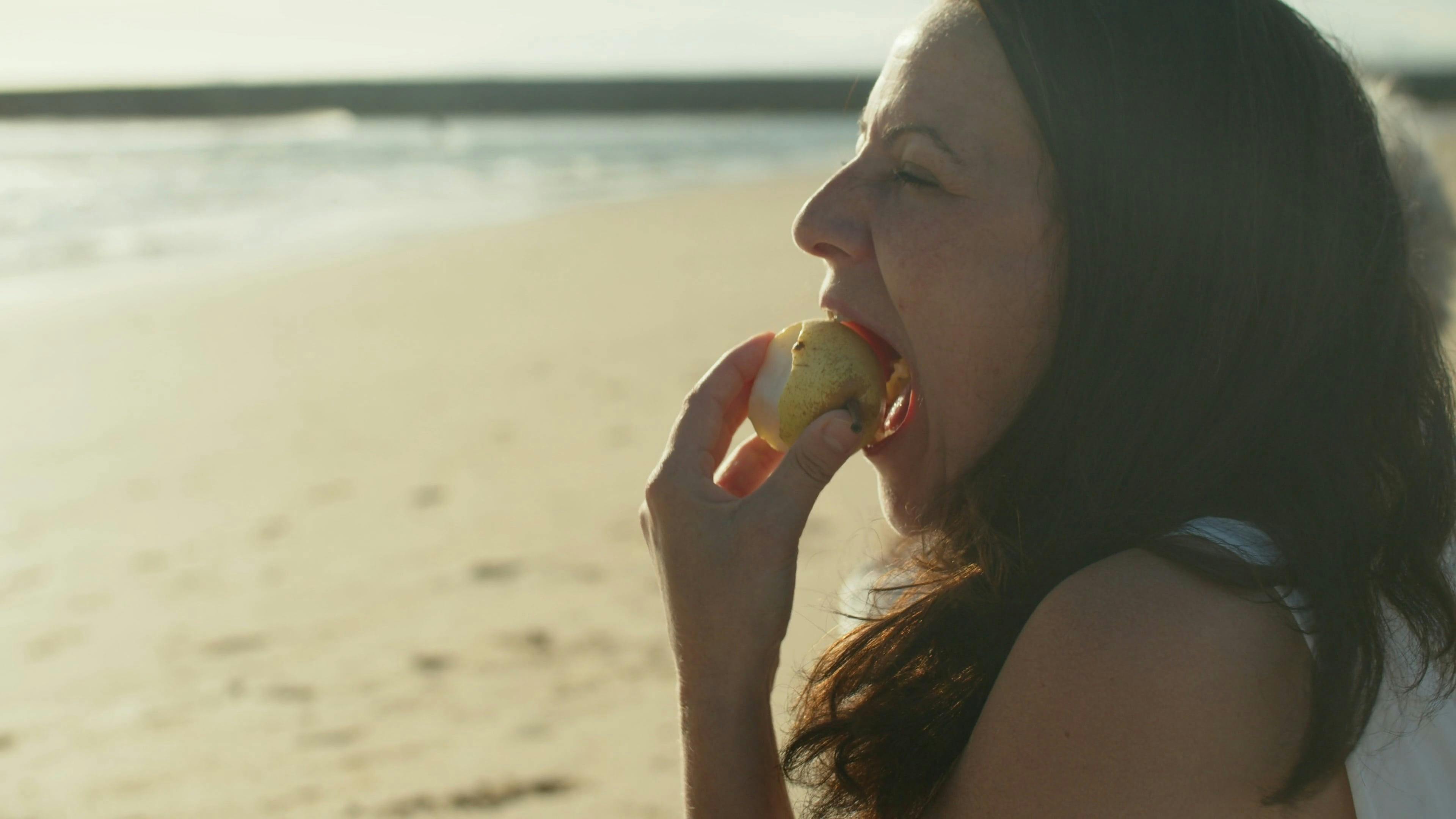 Woman Eating Fruit on Beach Free Stock Video Footage, Royalty-Free 4K ...