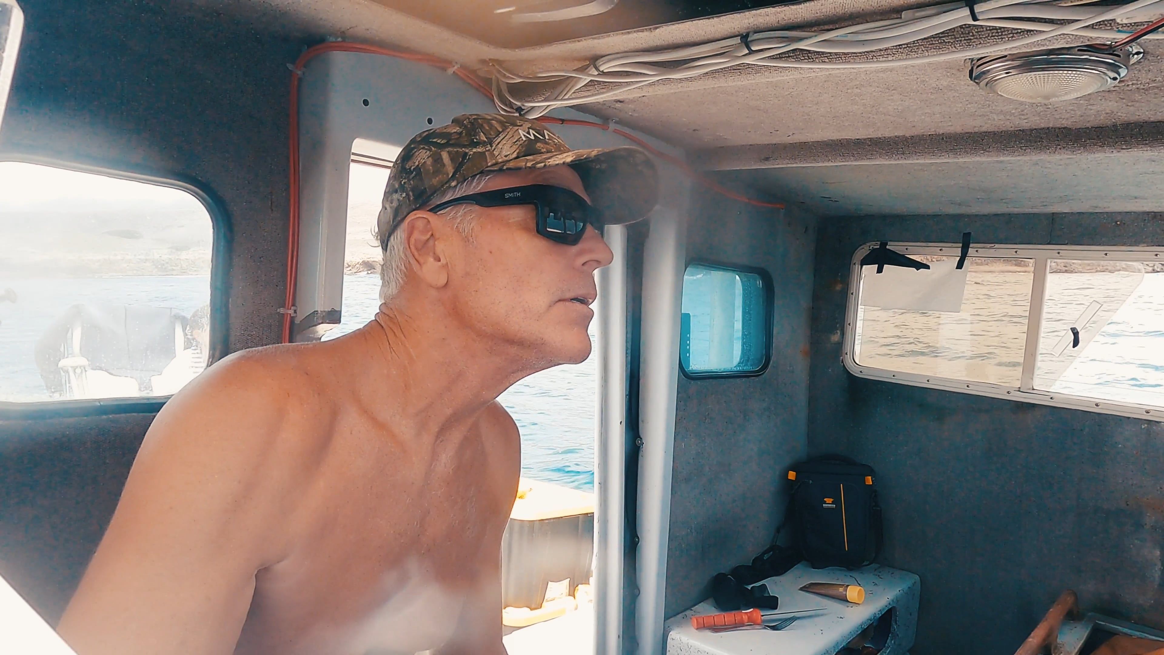 A Shirtless Man Inside the Cabin of a Boat · Free Stock Video