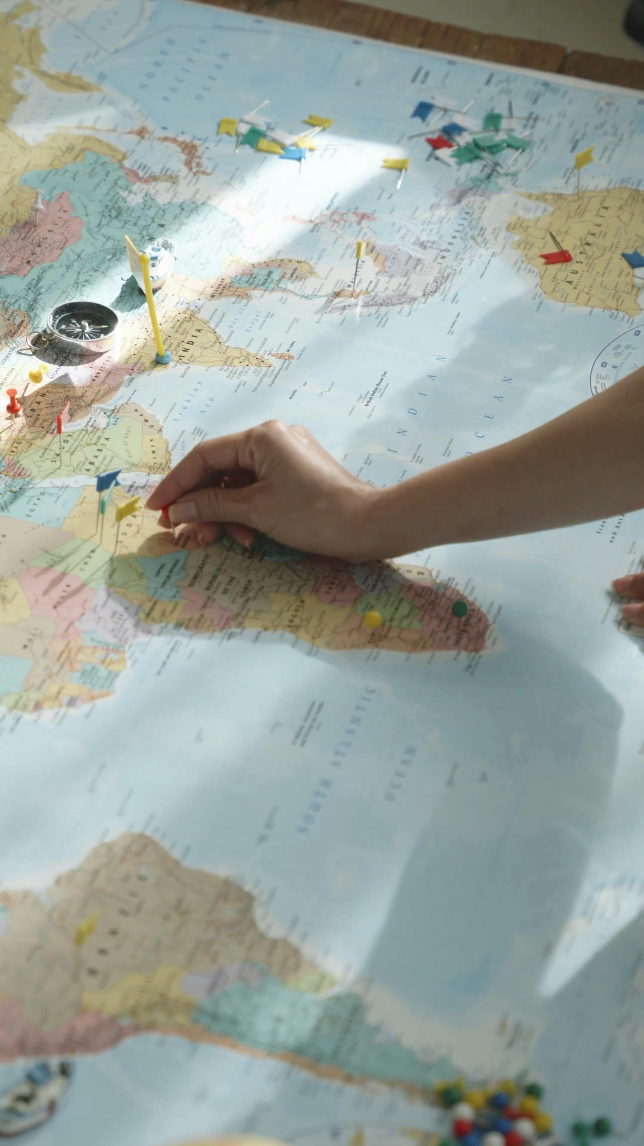 Two People Placing Pins on a World Map Free Stock Video Footage ...