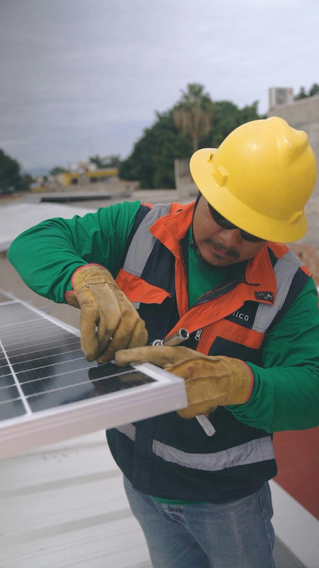 Man Using Socket Wrench To Mount Solar Panels · Free Stock Video