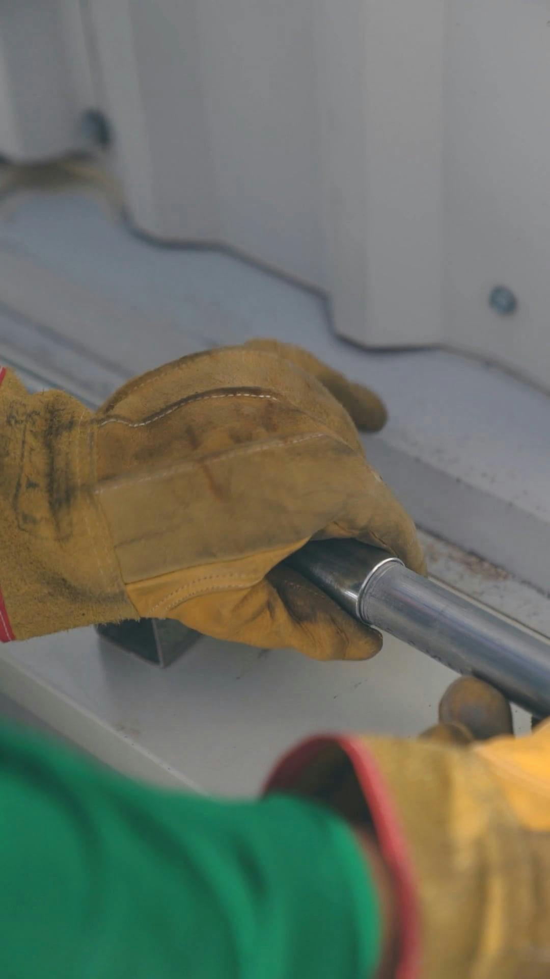 Person Mounting Pipes Together · Free Stock Video