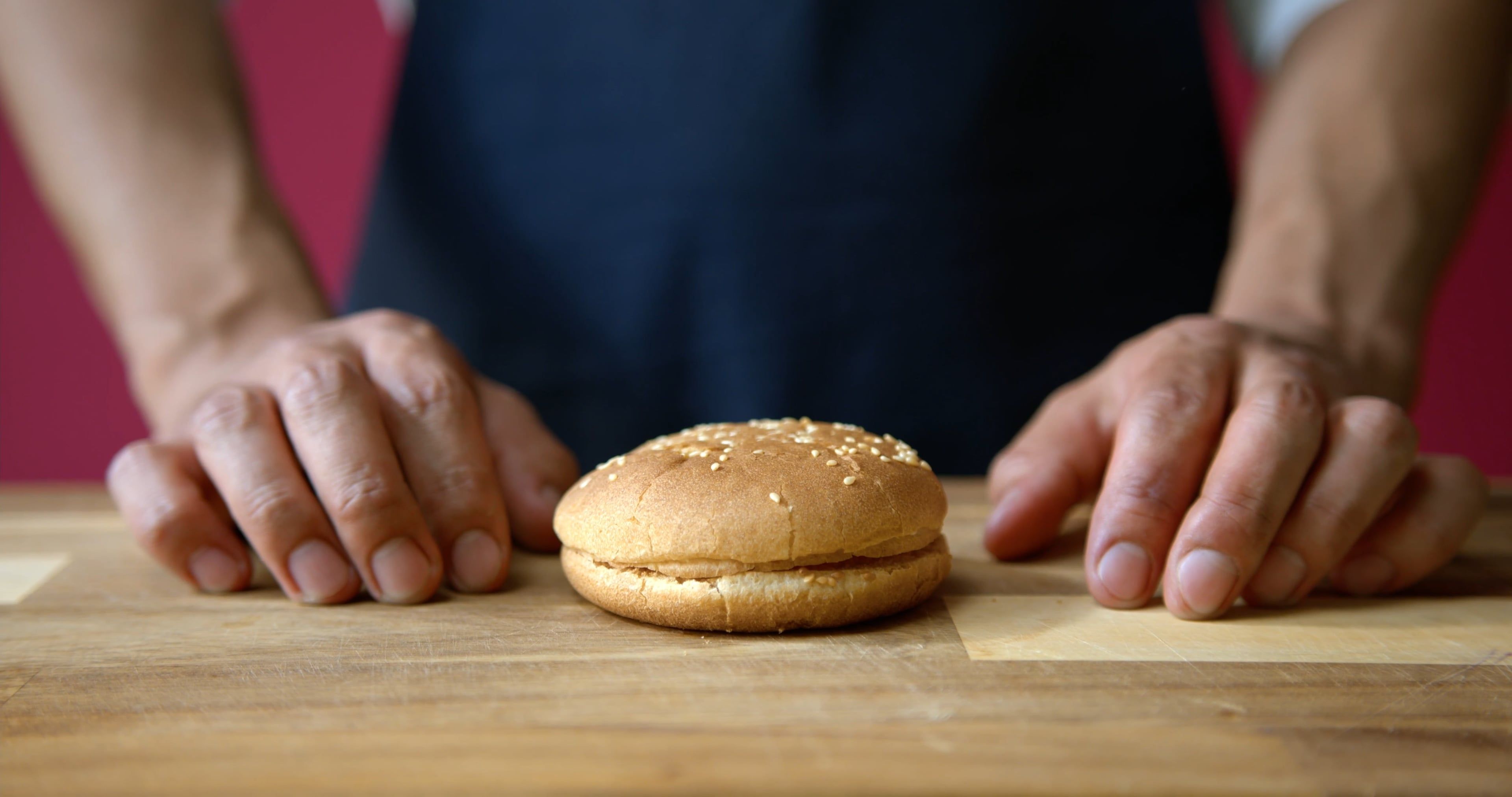Close up of a Person Breaking a Hamburger Bun in Half Free Stock Video ...