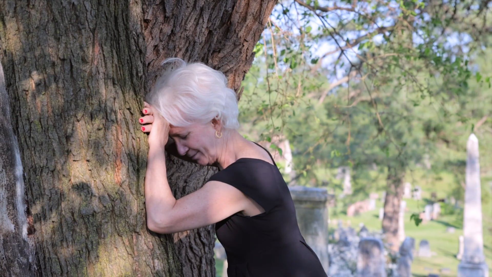A Grieving Woman Crying while Leaning on a Tree Trunk · Free Stock Video