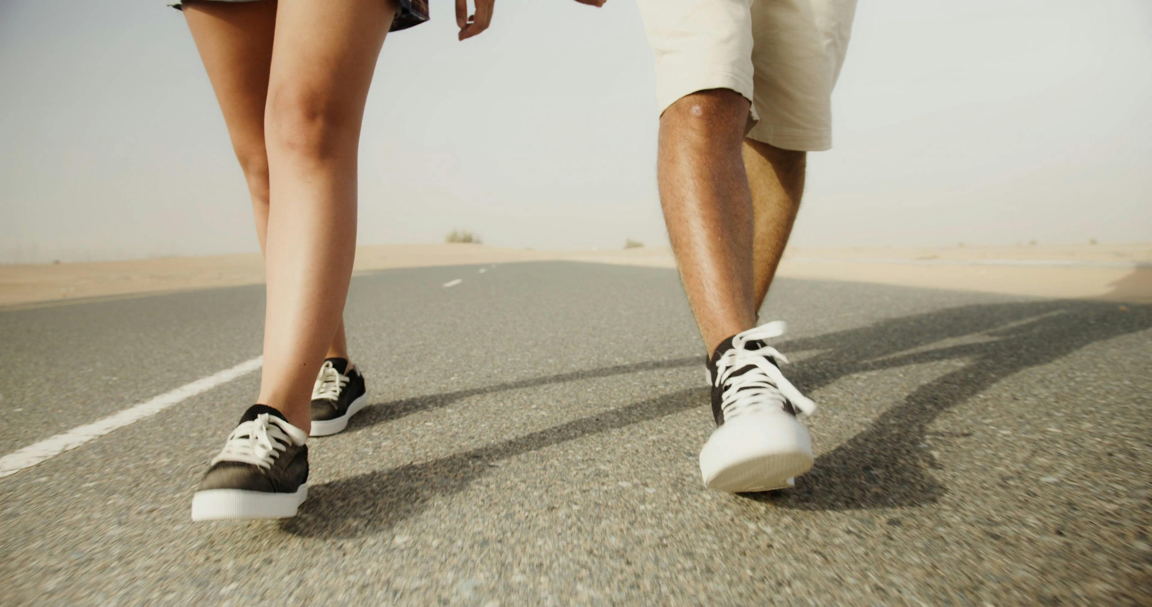 Knee Level Shot of People Walking on a Sandy Road Free Stock Video ...