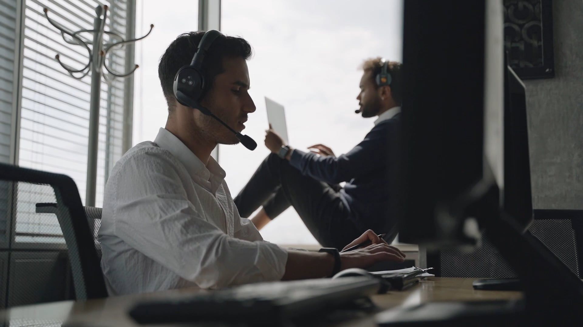 Man Taking Notes While Using a Computer · Free Stock Video