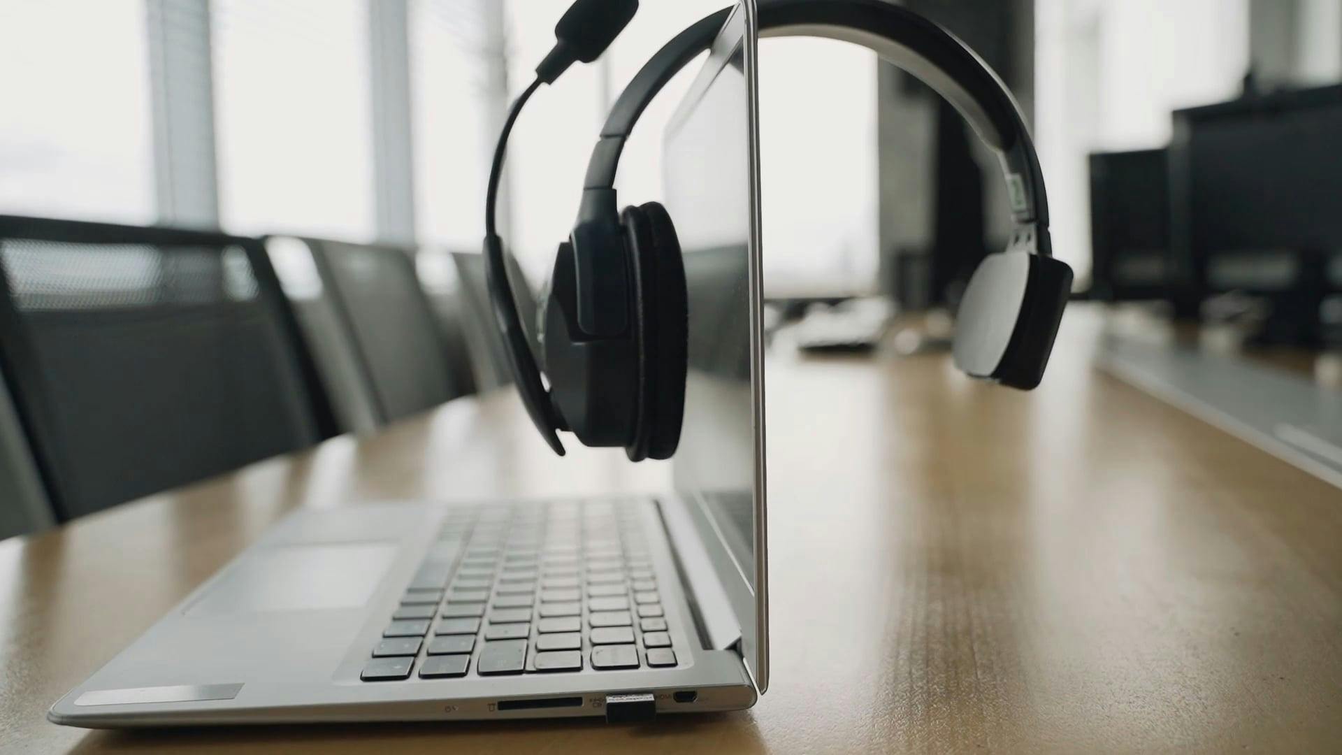 Headset Hanging on a Laptop · Free Stock Video