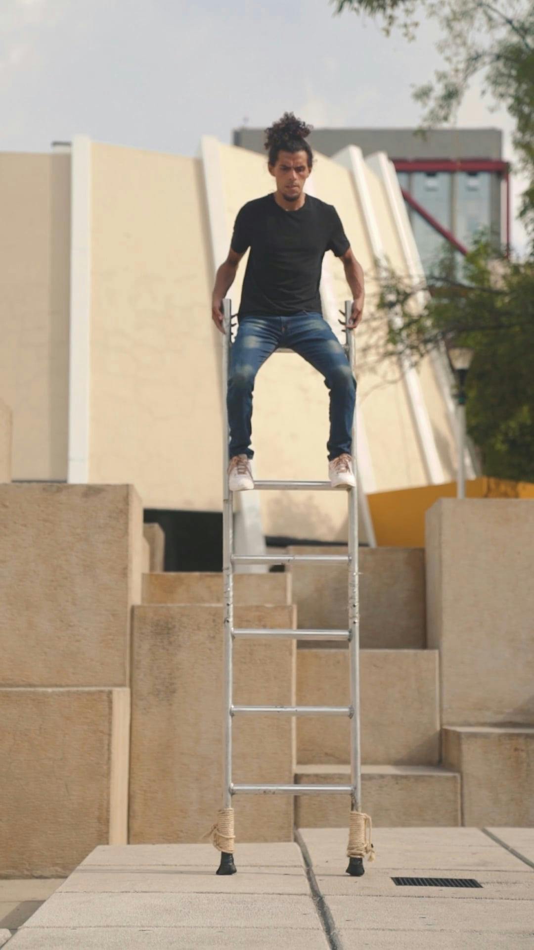 A Man Balancing while Sitting on Top of a Ladder Free Stock Video ...