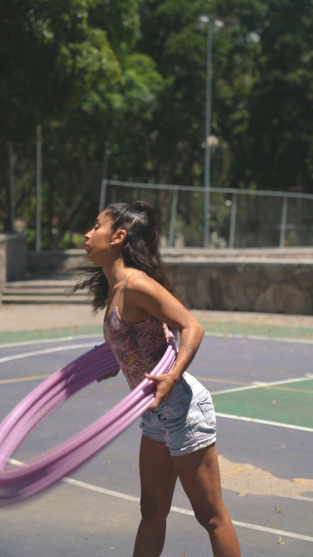 A Woman Holding a Hula Hoop While Looking at Camera · Free Stock Video
