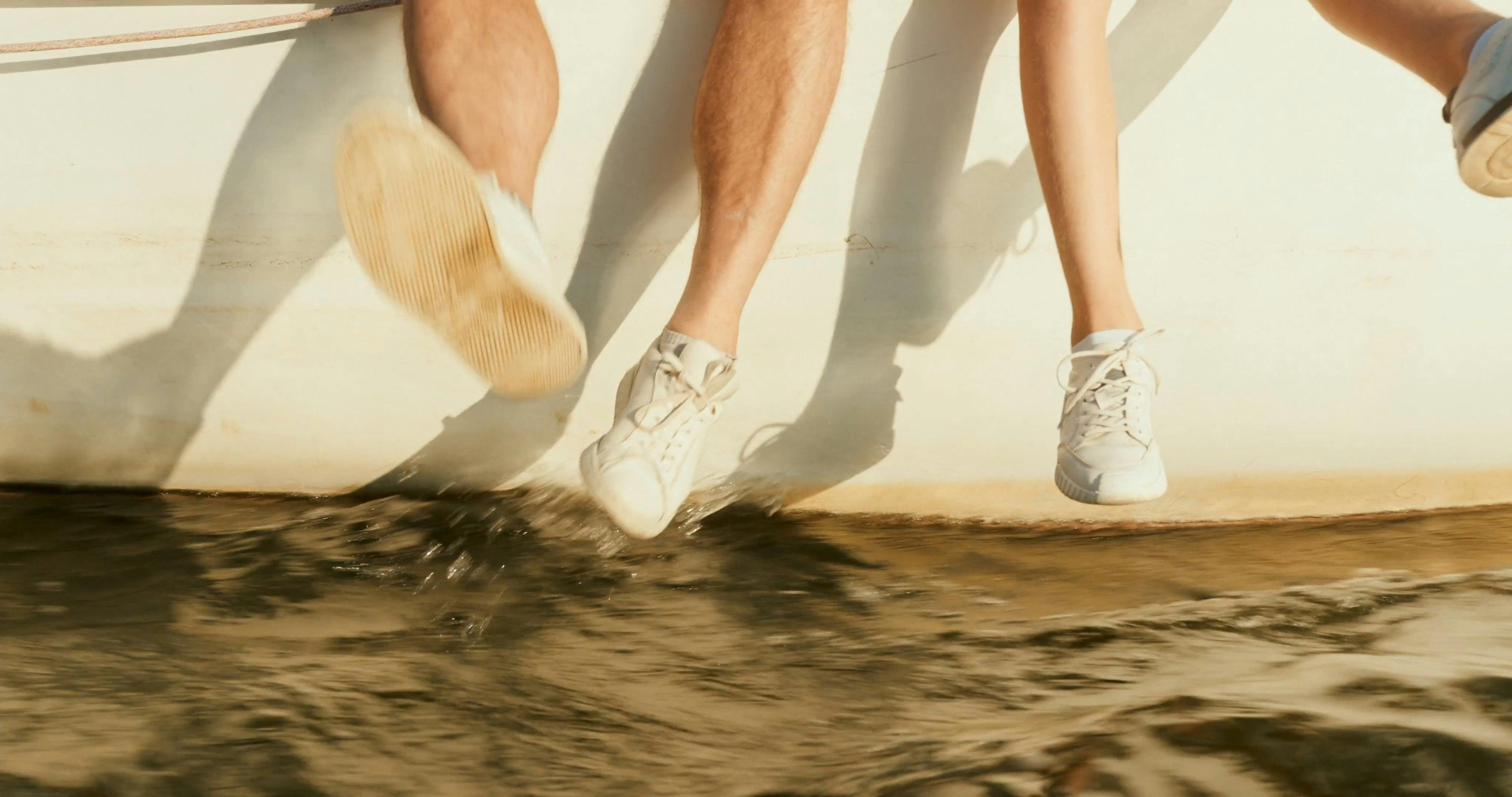 Close-up Footage of People Swaying their Legs While Sitting on a Moving ...